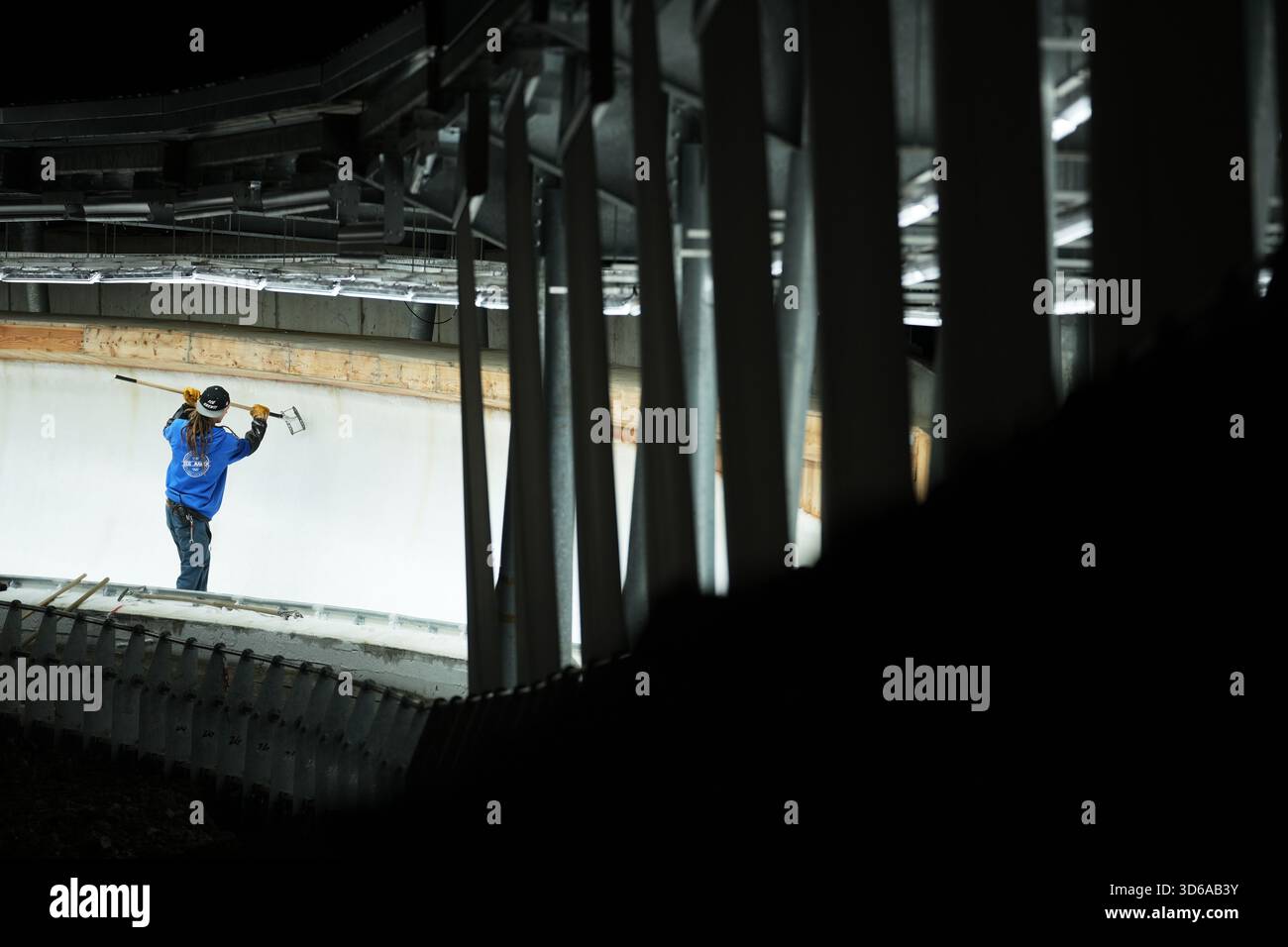 A man works on the track ahead of a three-day skeleton and bobsled ...