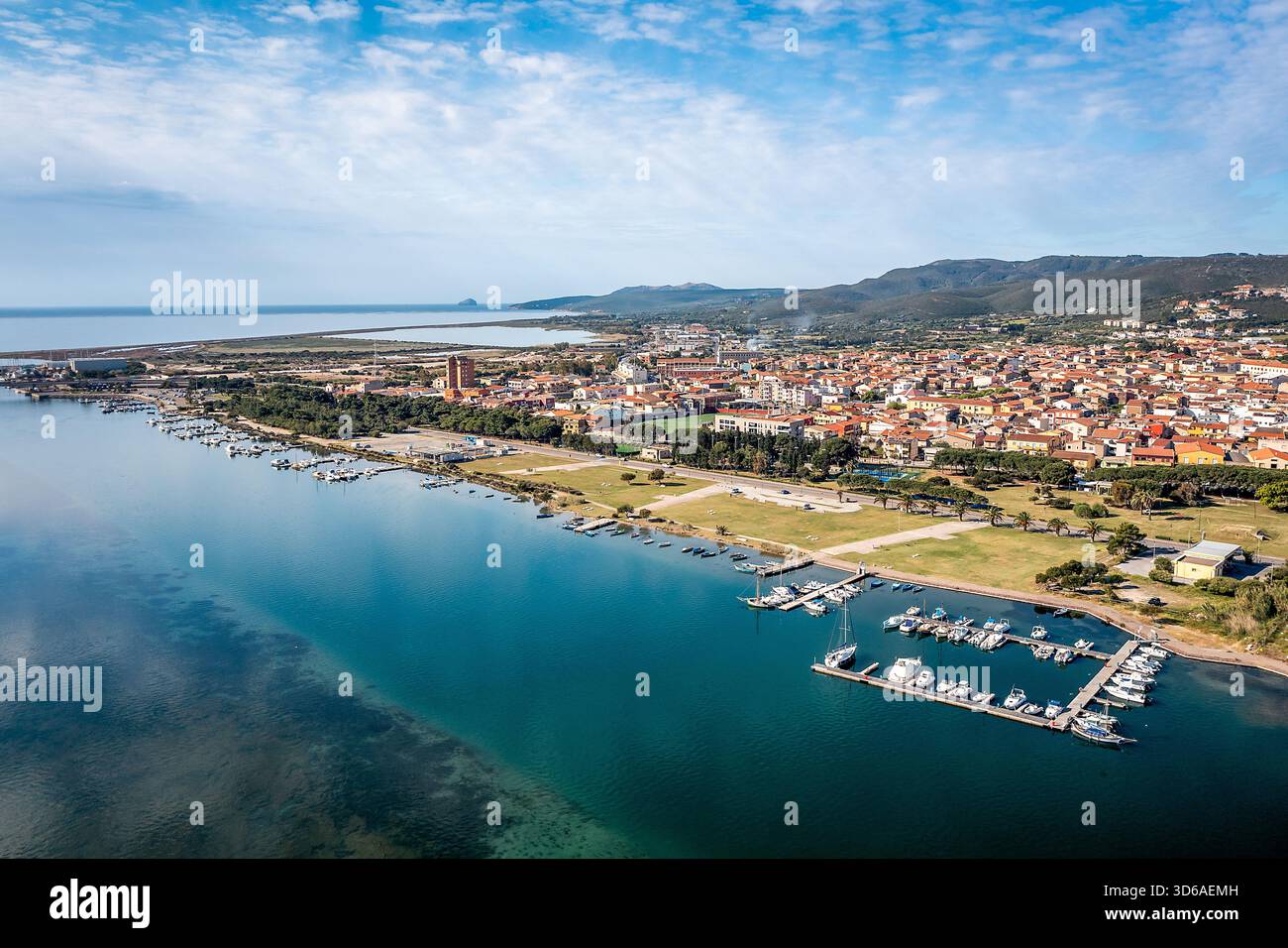 Aerial scene of a seaside town with a busy marina, boats, a calm ...
