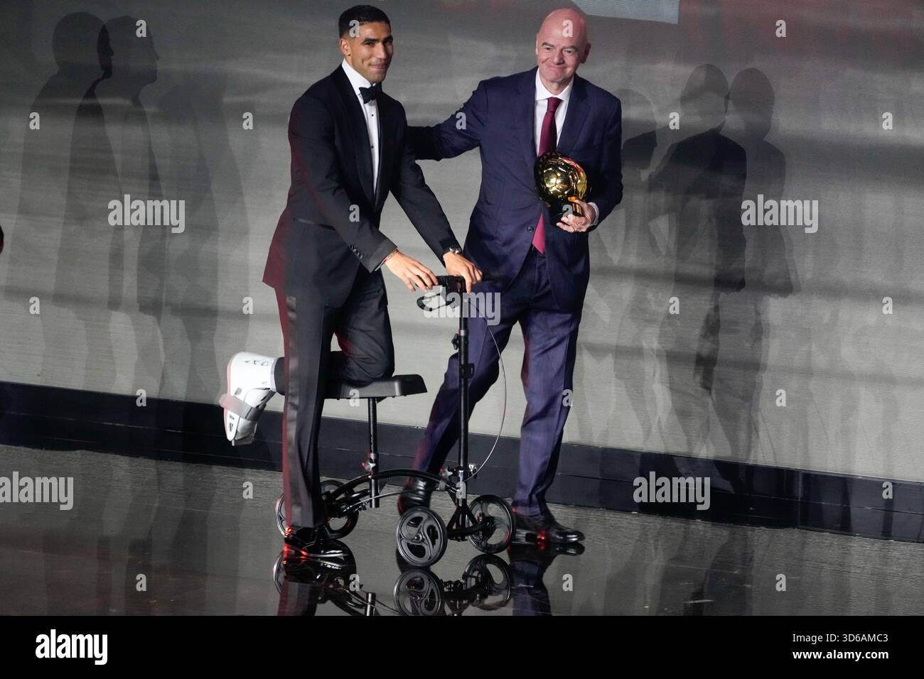 Morocco's Achraf Hakimi is greeted by FIFA president Gianni Infantino ...