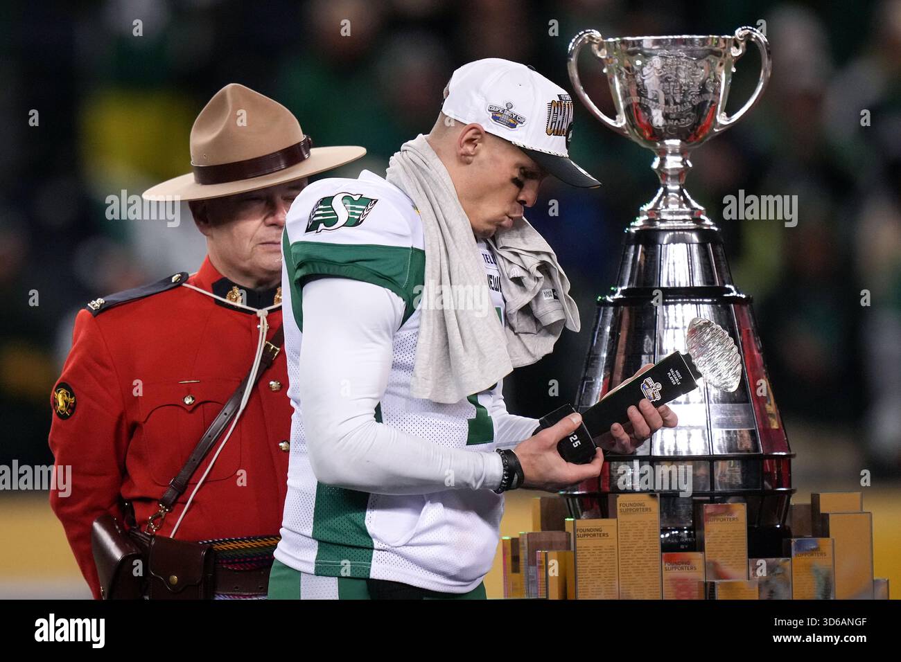 Saskatchewan Roughriders quarterback Trevor Harris holds the MVP trophy ...