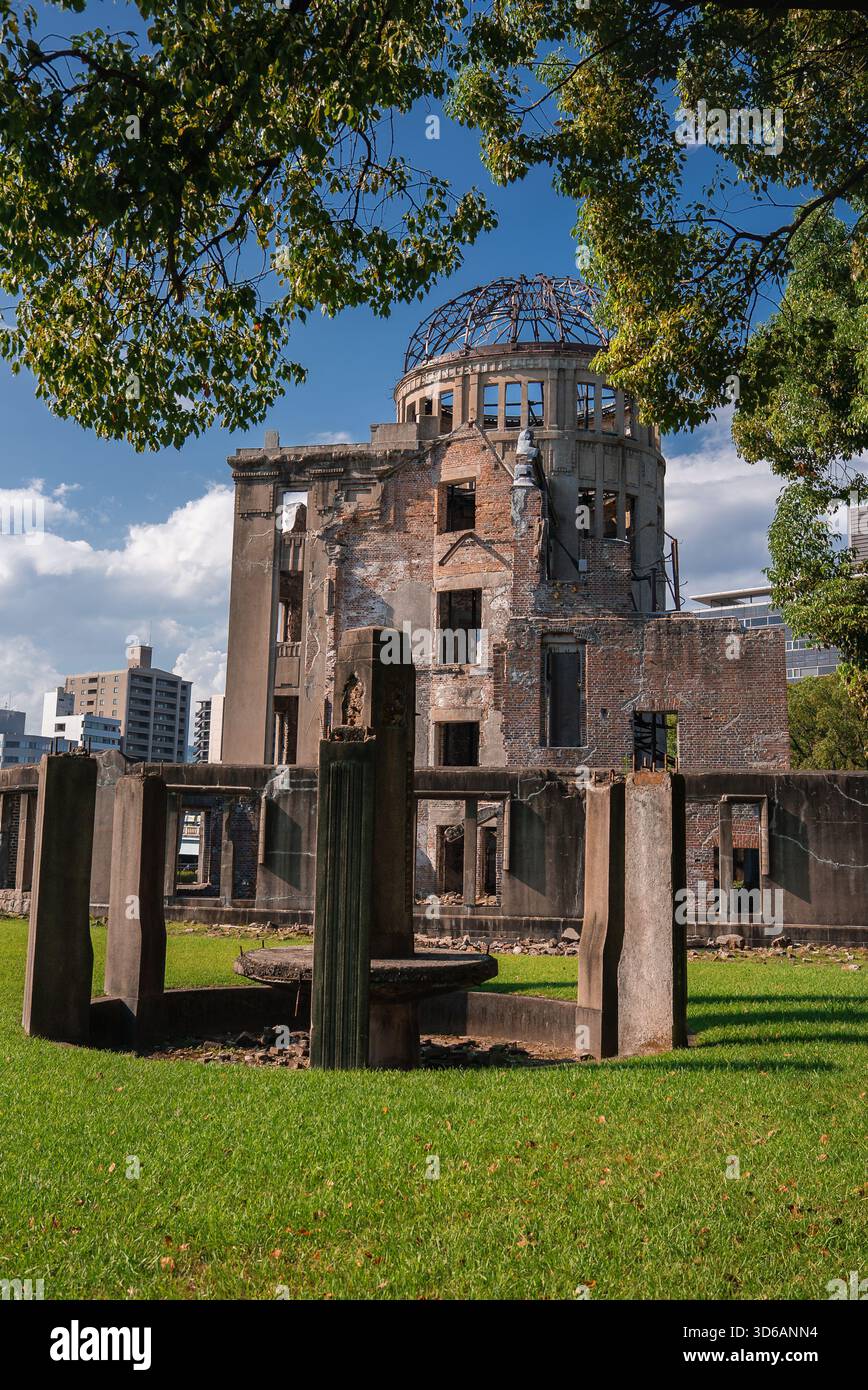Atomic Bomb Dome behind stone monument at Hiroshima Peace Park Stock ...