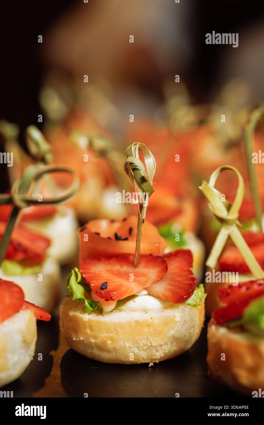 Mini canapes with smoked salmon, cream cheese and strawberry on toasted ...