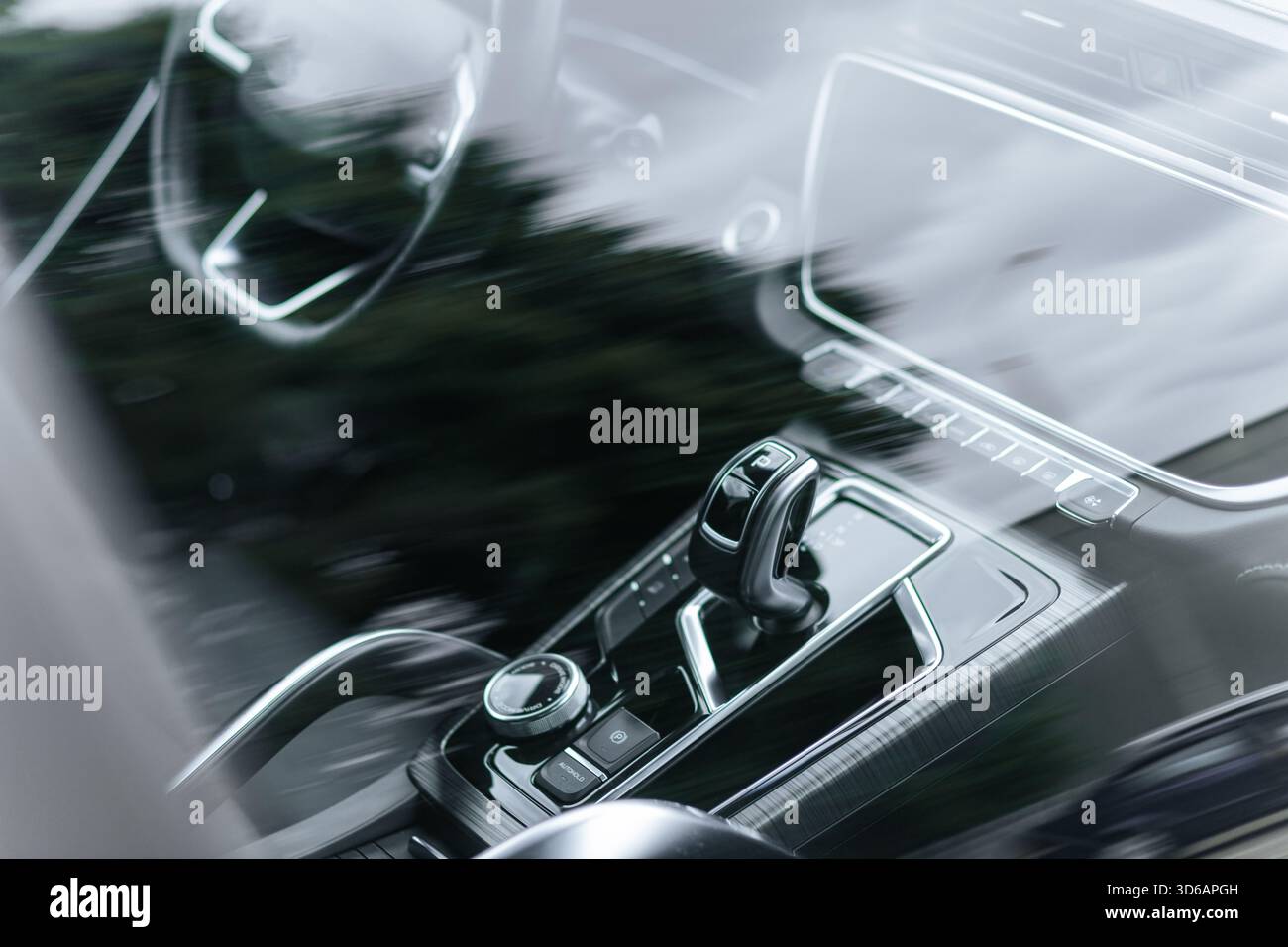 Car interior captured through glass window, showing gear shifter, drive ...