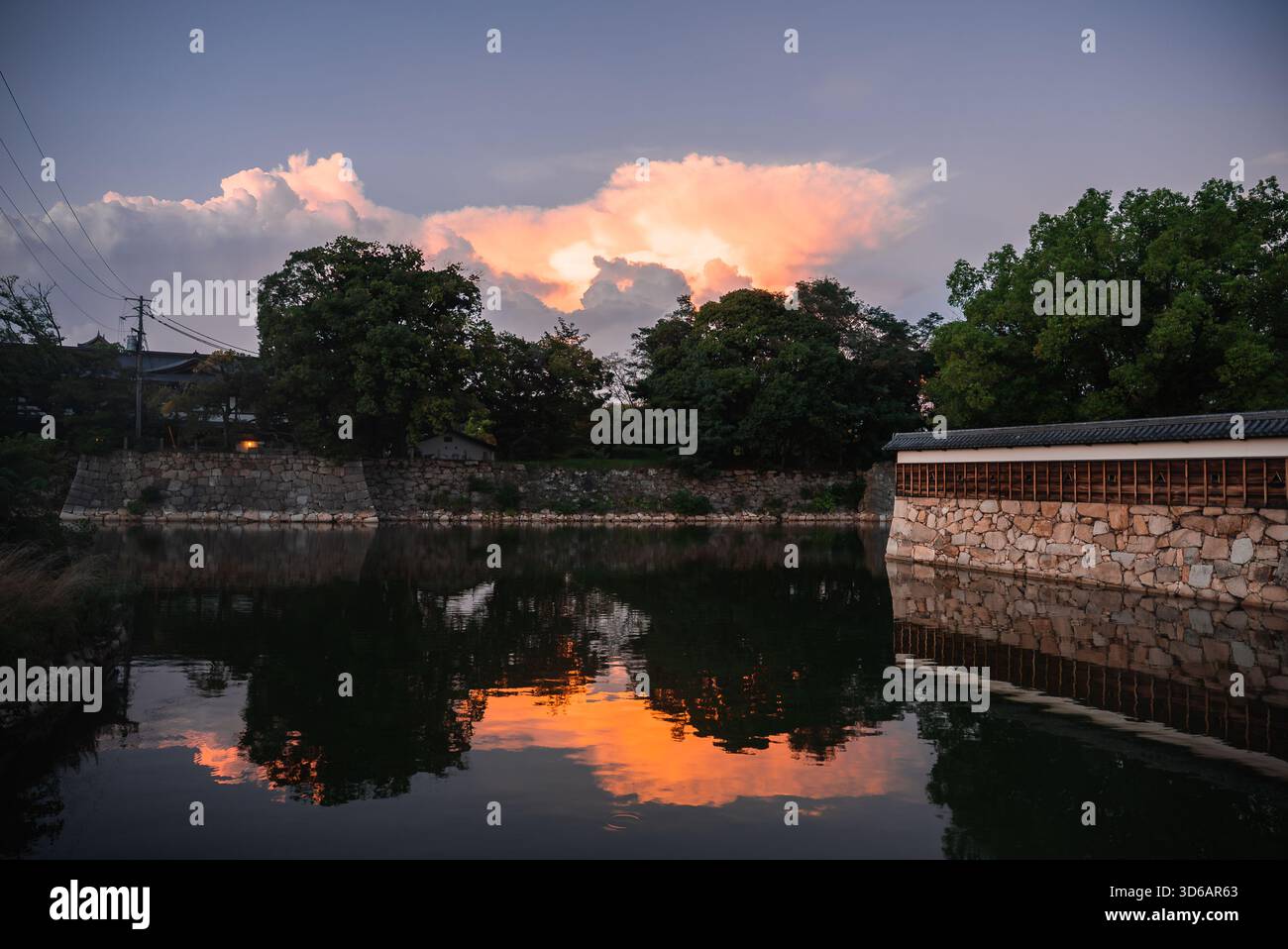 Osaka Castle moat and stone walls at sunset in Osaka, Japan Stock Photo ...
