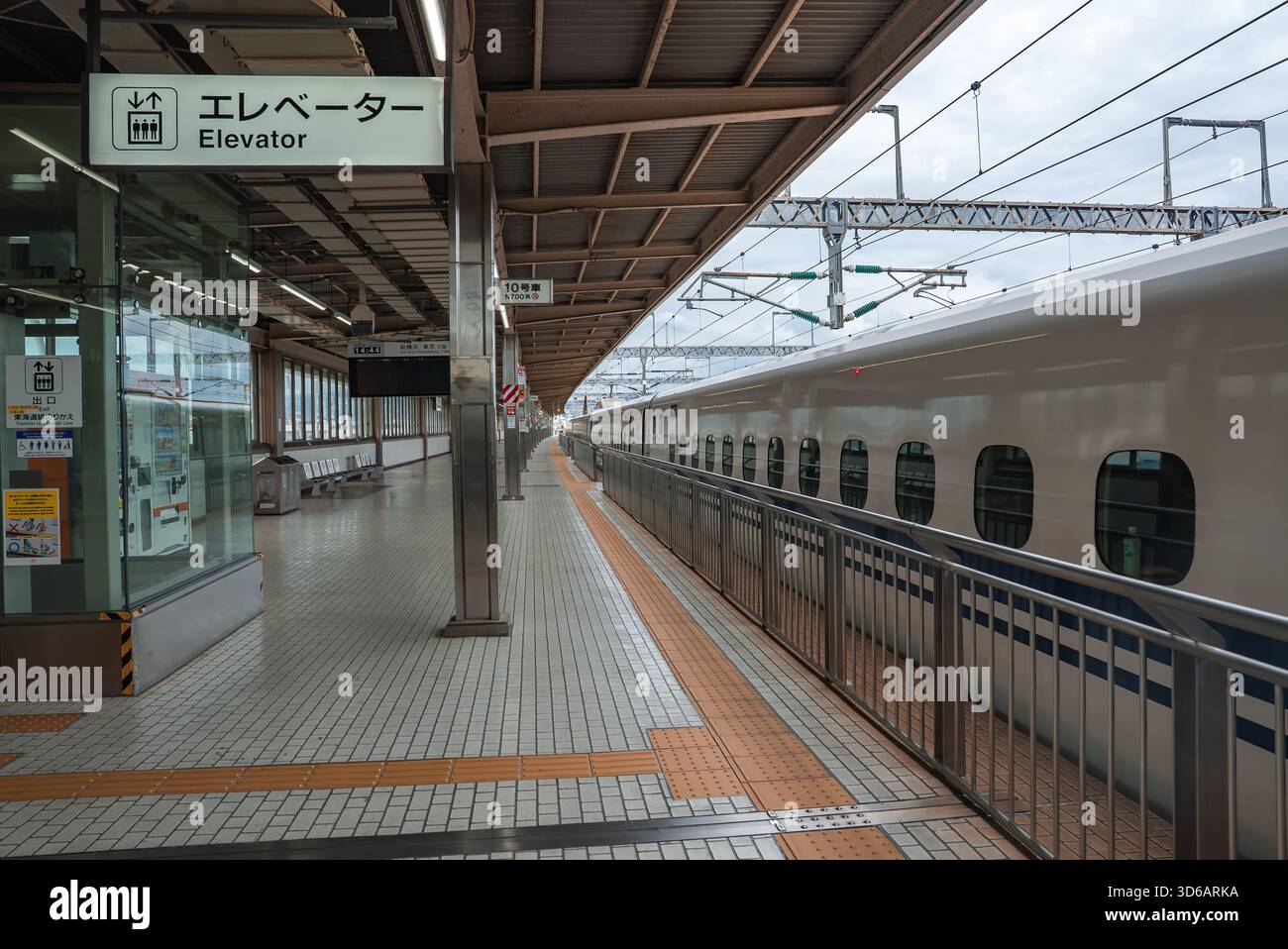 Shinkansen at elevated platform in Osaka station with catenary lines ...