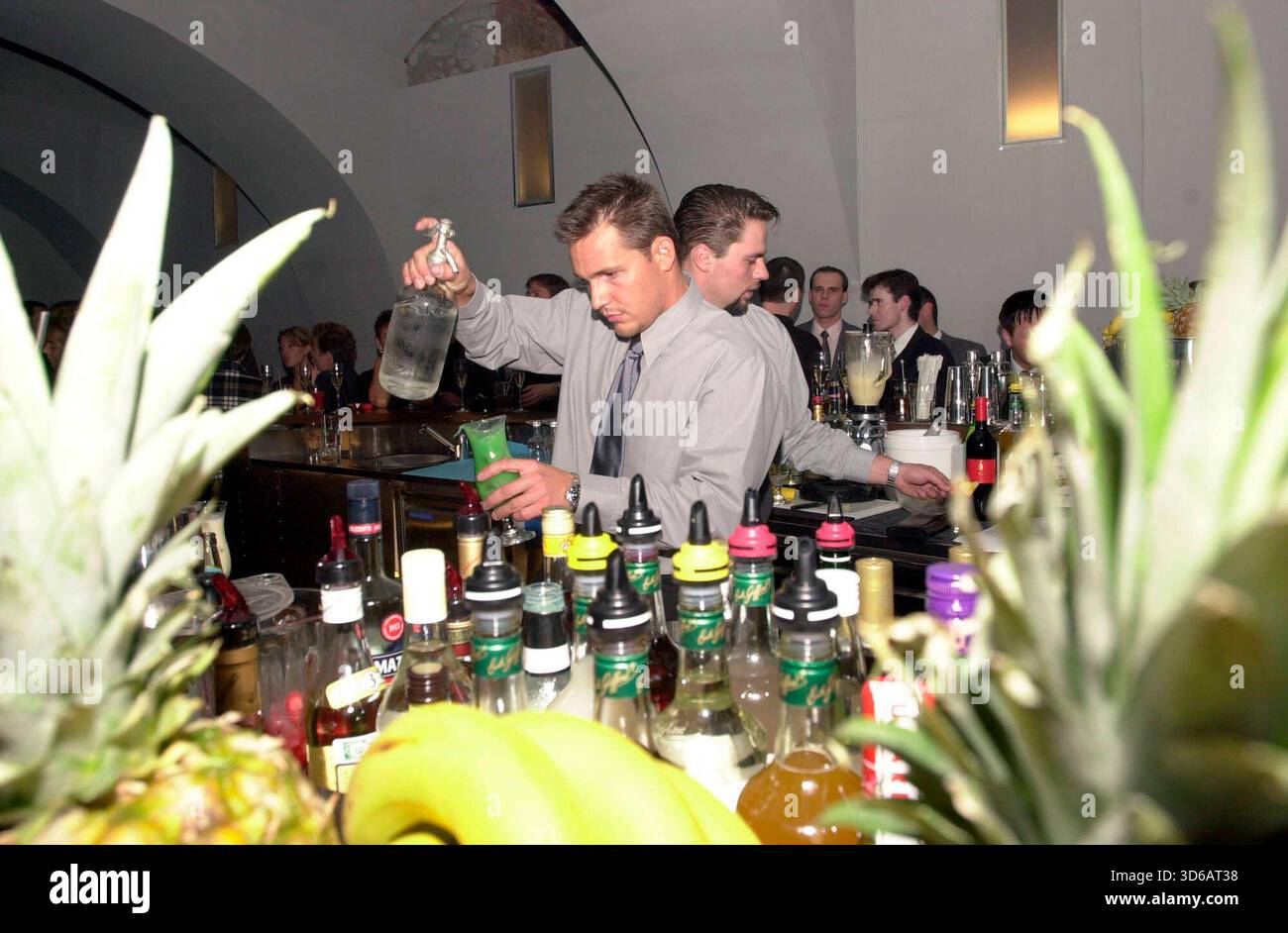 a barkeeper or bartender mixing drinks together in a bar barkeeper ...