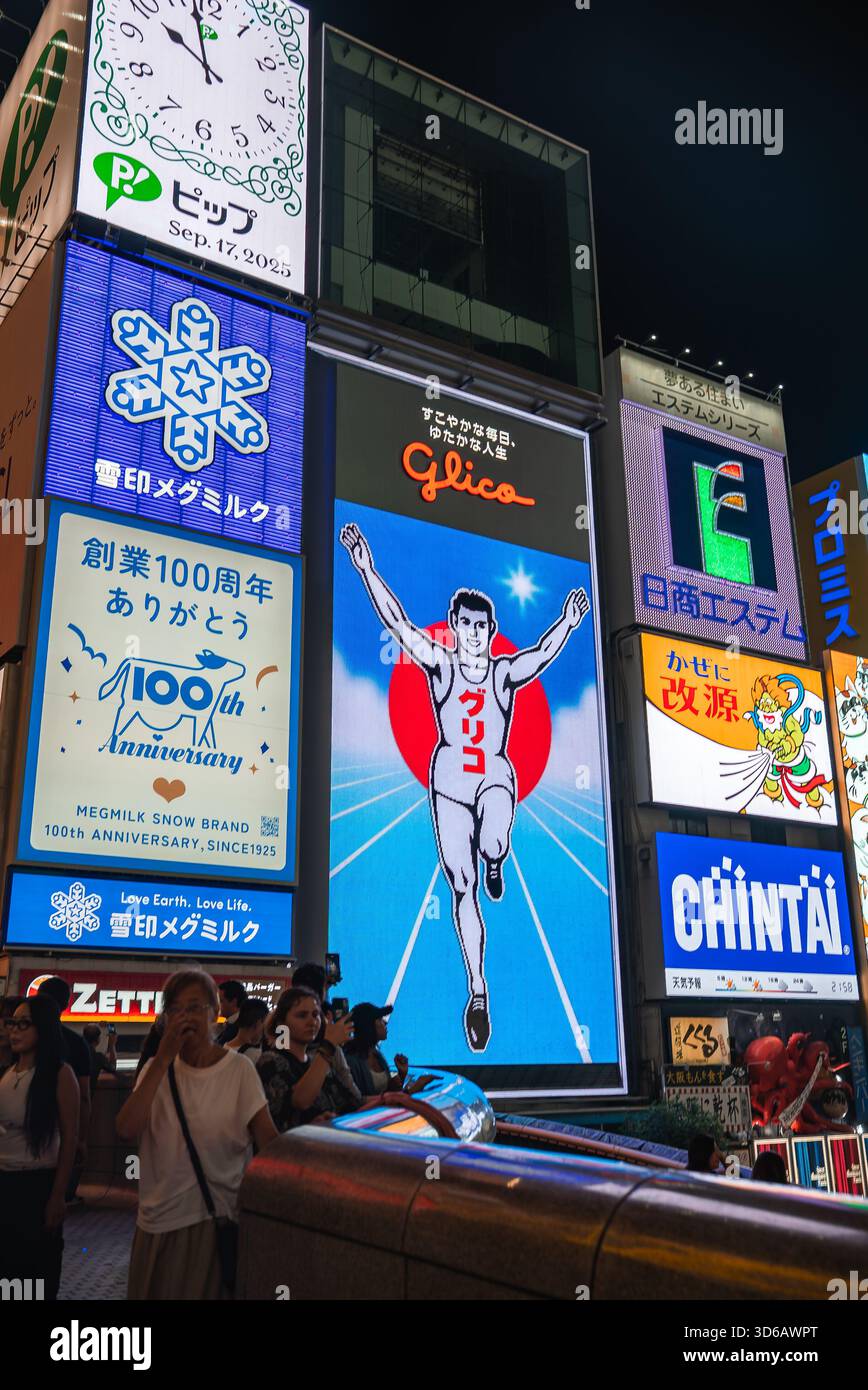 Glico Running Man and neon signs in Dotonbori, Osaka at night Stock ...