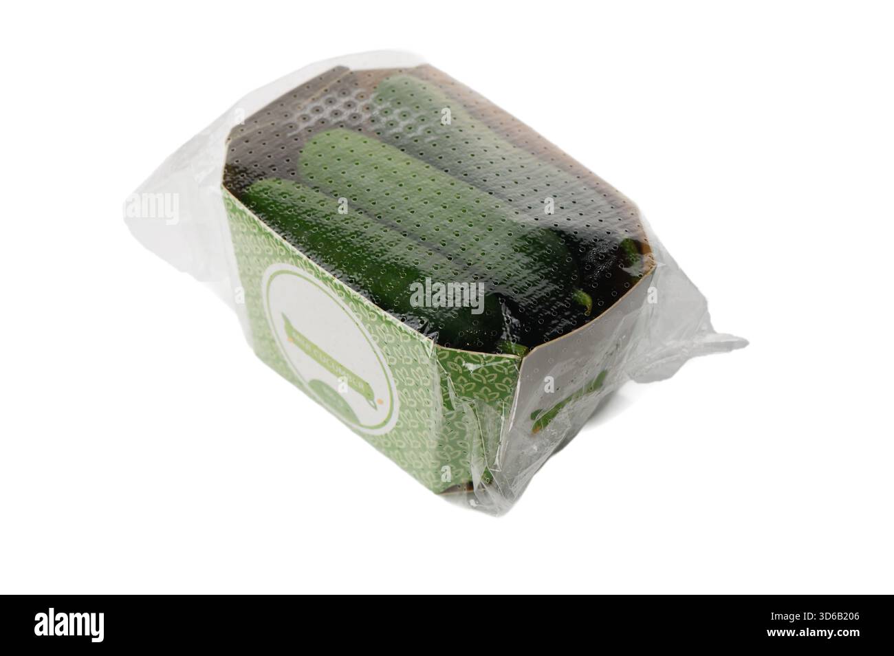 Crisp mini cucumbers displayed in eco-friendly cardboard box against ...
