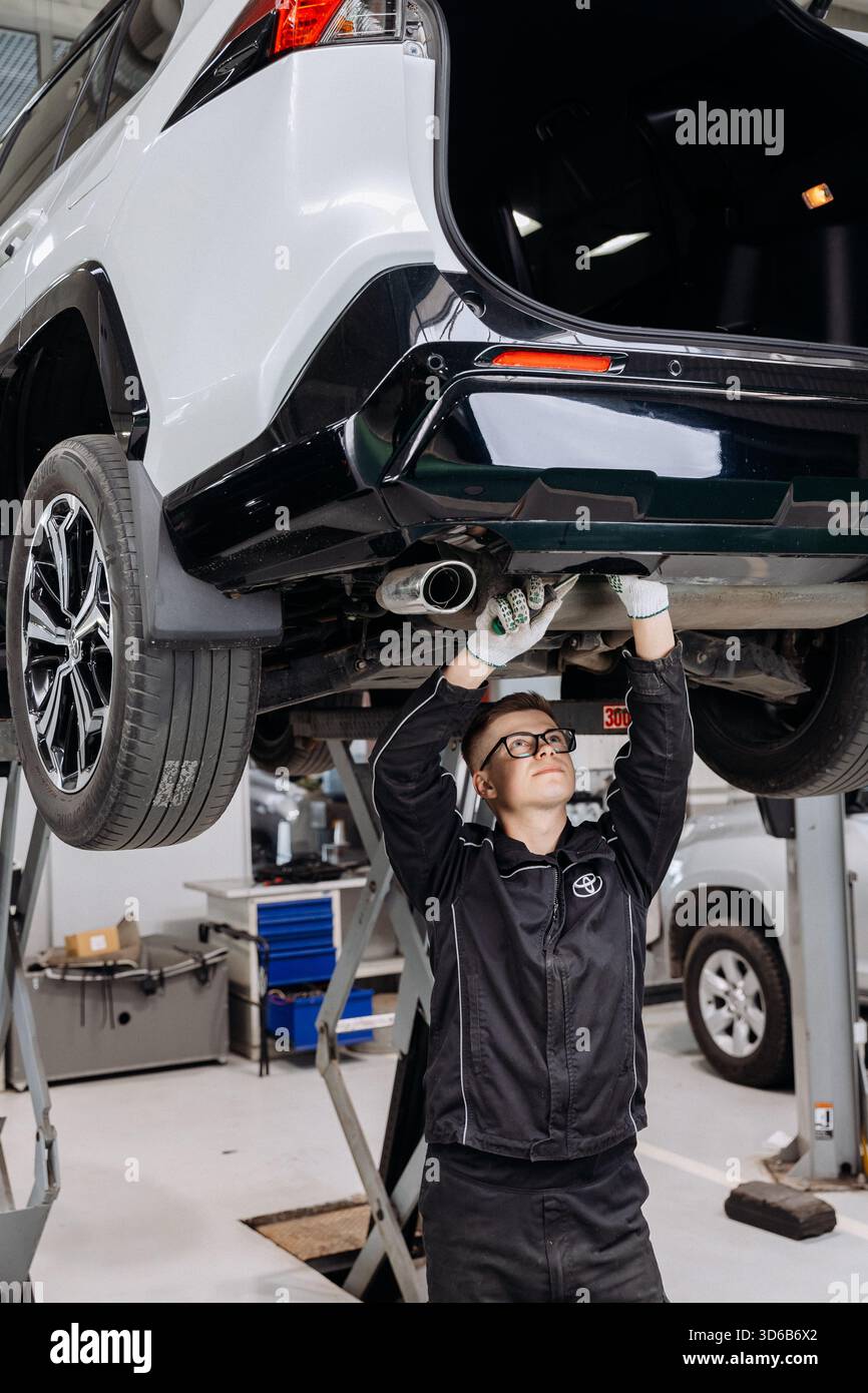 Vinnitsya, Ukraine - 15 of May 2025: Toyota mechanic inspects SUV ...