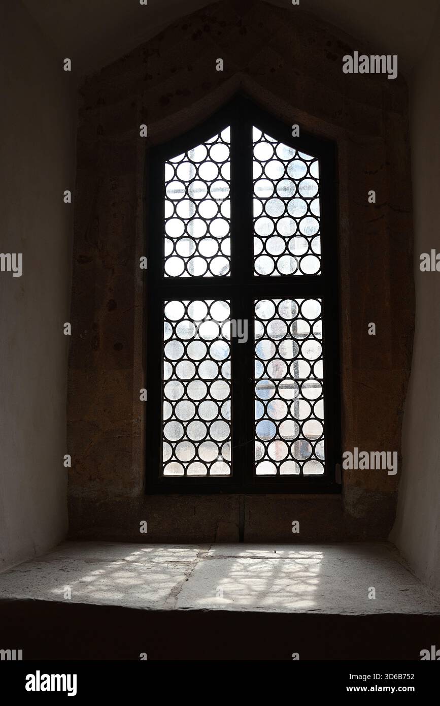 A historic window with leaded glazing and round bullseye glass panes ...