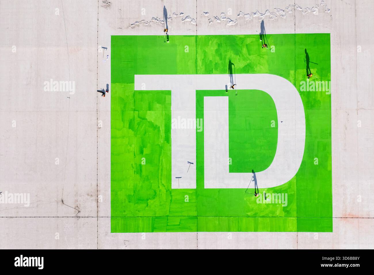 Workers paint a TD logo on the roof of TD Coliseum, the revamped arena ...