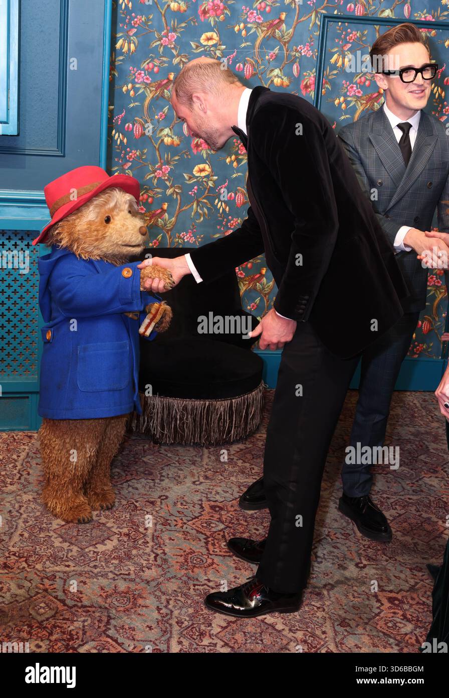 The Prince of Wales shakes hands with the Paddington Bear from the ...