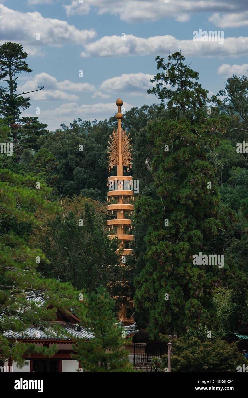 Golden pagoda spire among cedar and pine at a Nara temple complex Stock ...