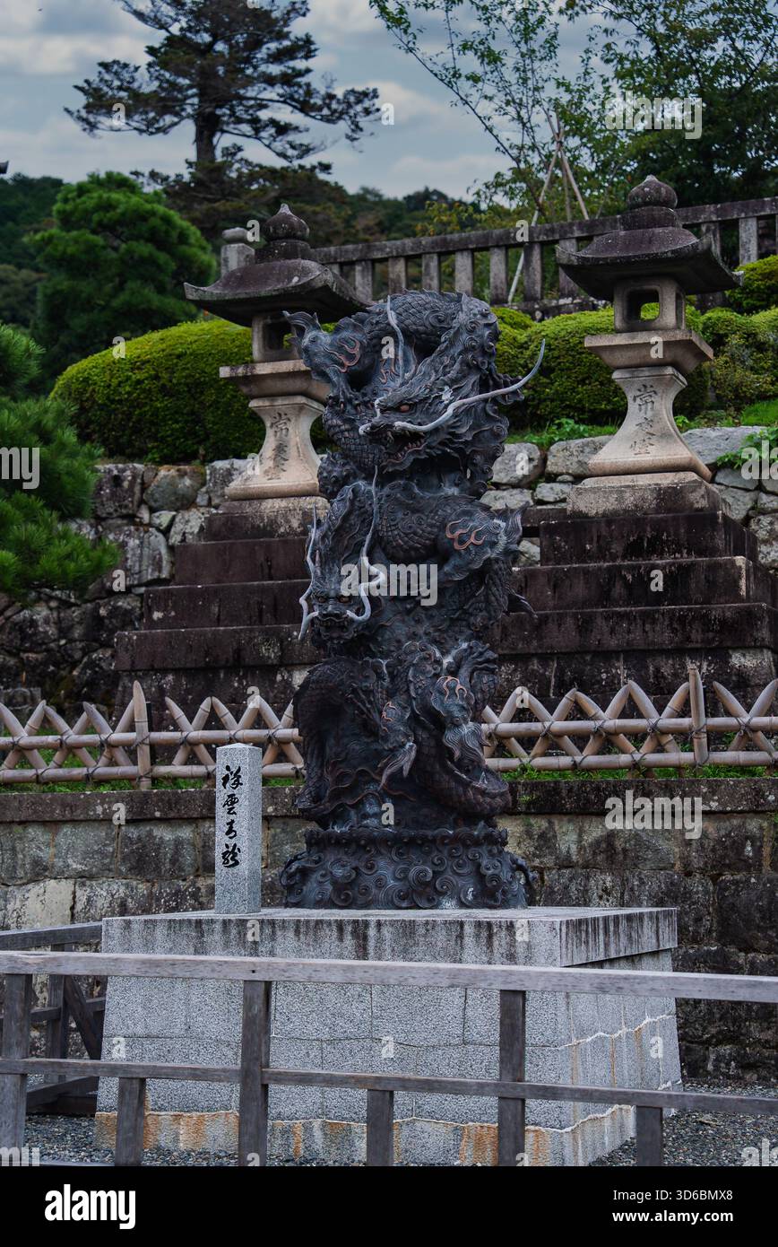 Dragon statue in Kyoto temple garden with lanterns and mossy steps ...