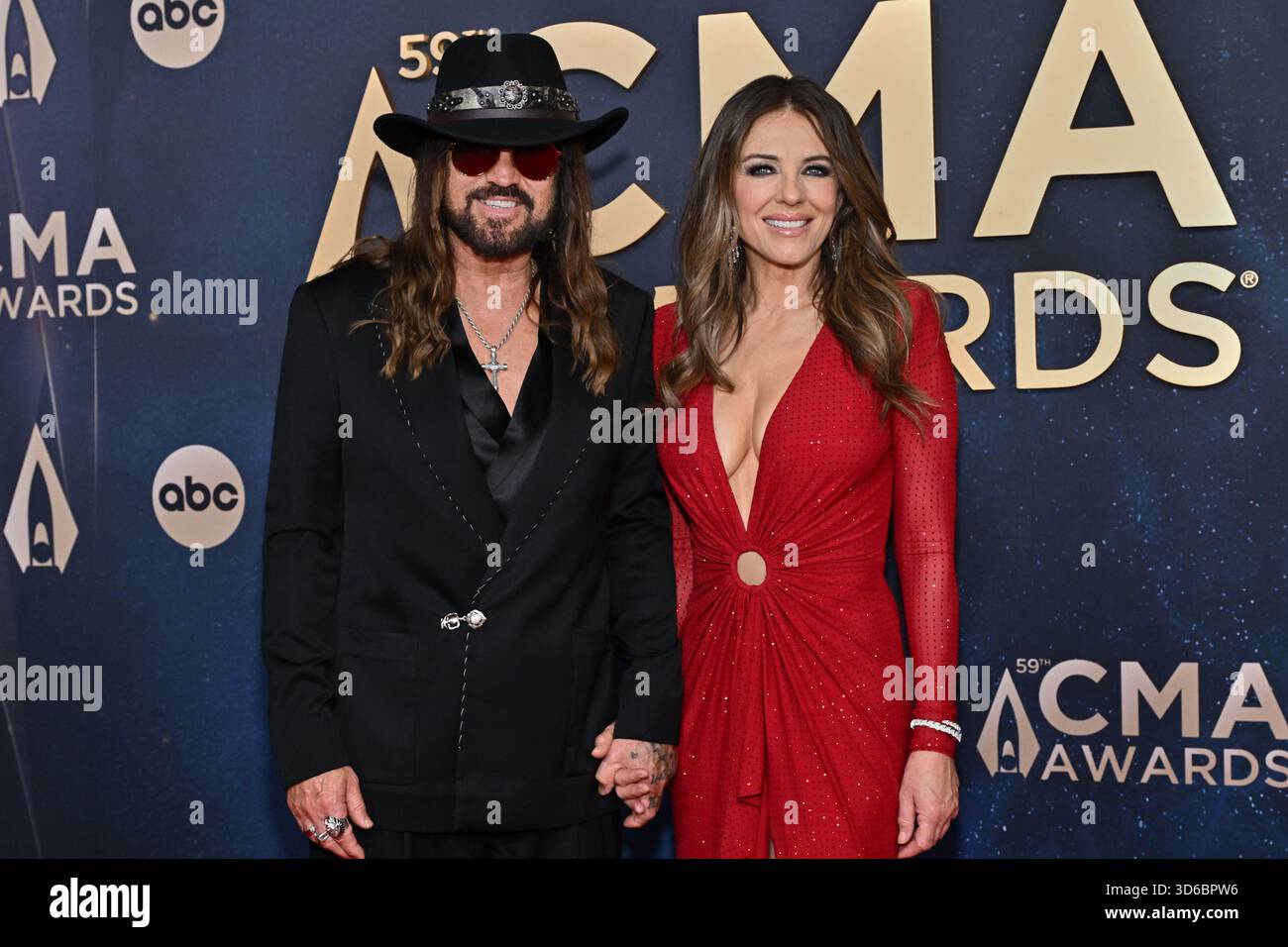 Billy Ray Cyrus, left, and Elizabeth Hurley arrive at the 59th Annual ...