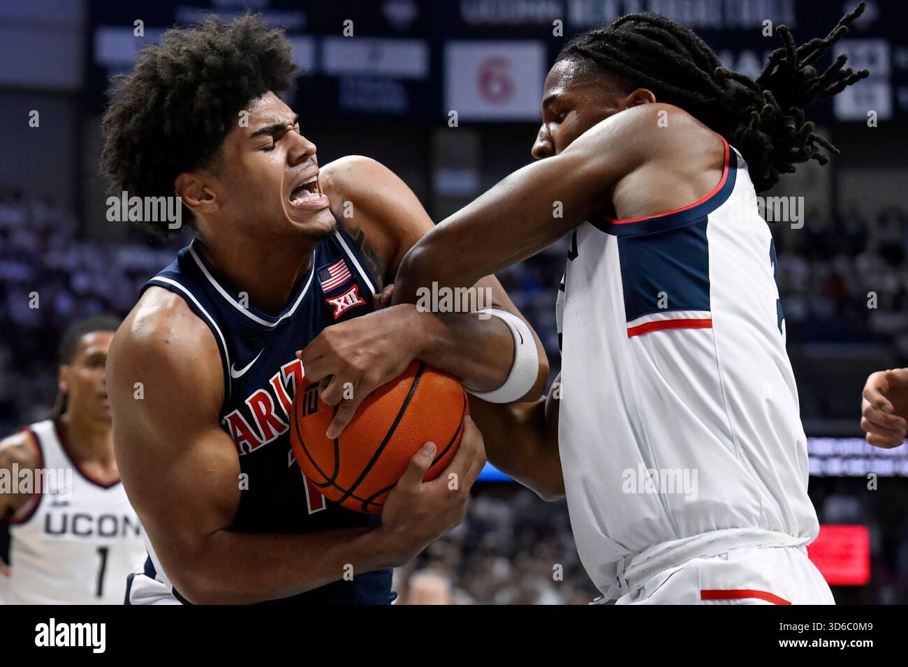Arizona forward Koa Peat and UConn guard Silas Demary Jr., right, fight ...