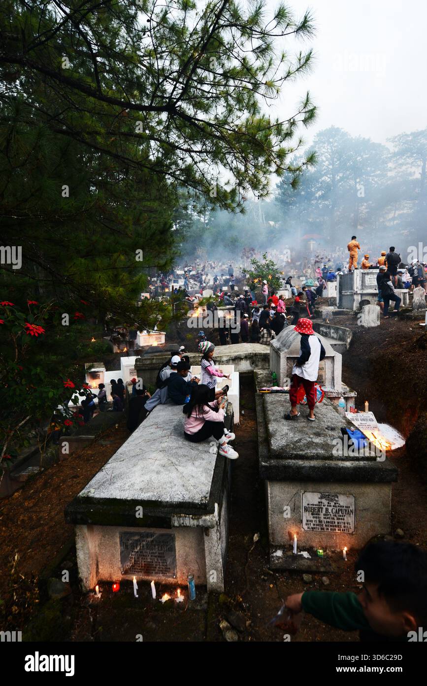 Families light bonfires at the grave of their ancestors at the night of ...
