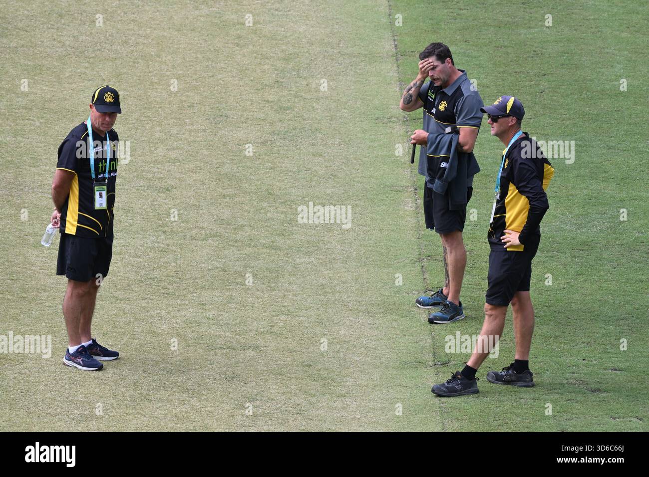 West Australian Head Curator Isaac McDonald (centre) inspects the pitch ...
