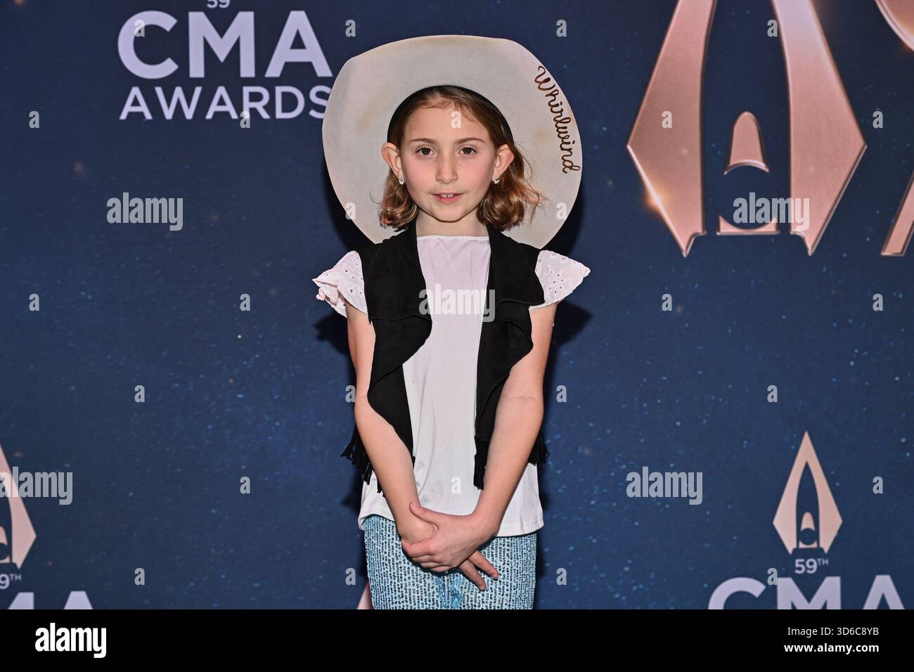 Marcella Farris poses in the press room wearing a hat from Lainey ...