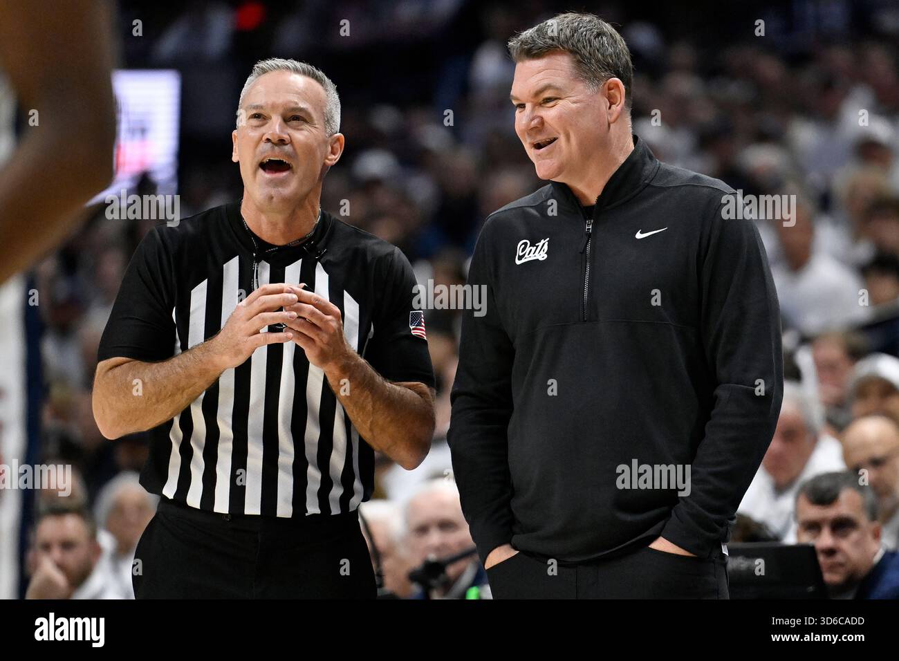 Arizona head coach Tommy Lloyd, right, talks with referee Ron Groover ...