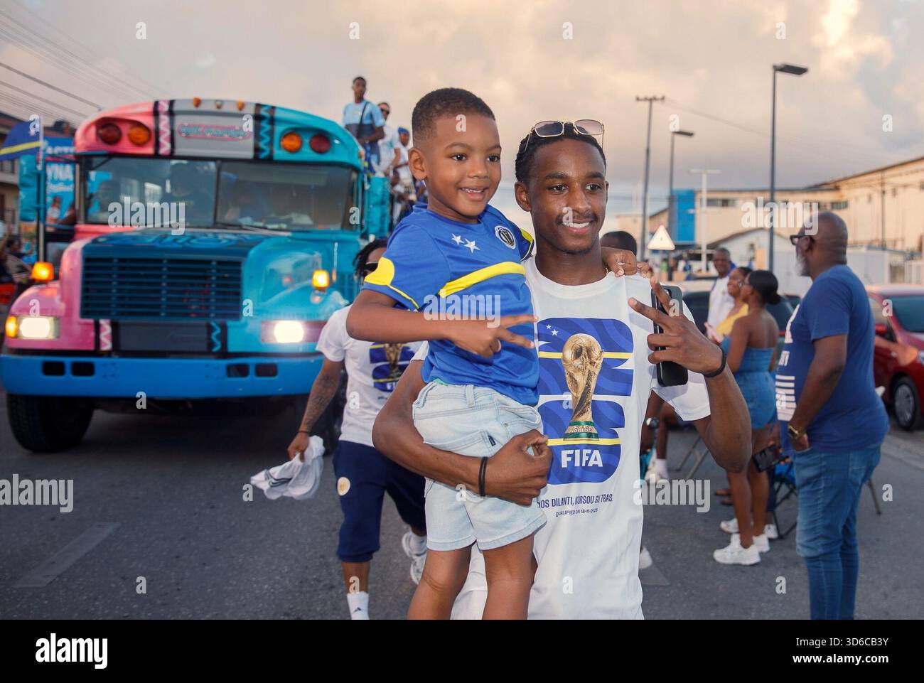 Curaçao's Arjany Martha poses for a photo with a child during a parade ...