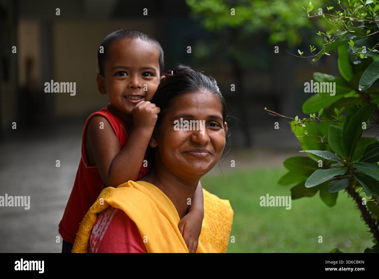 A child of the Mamata Day Care Center poses for a photo with a day mother at Gazipur. (Photo by ...