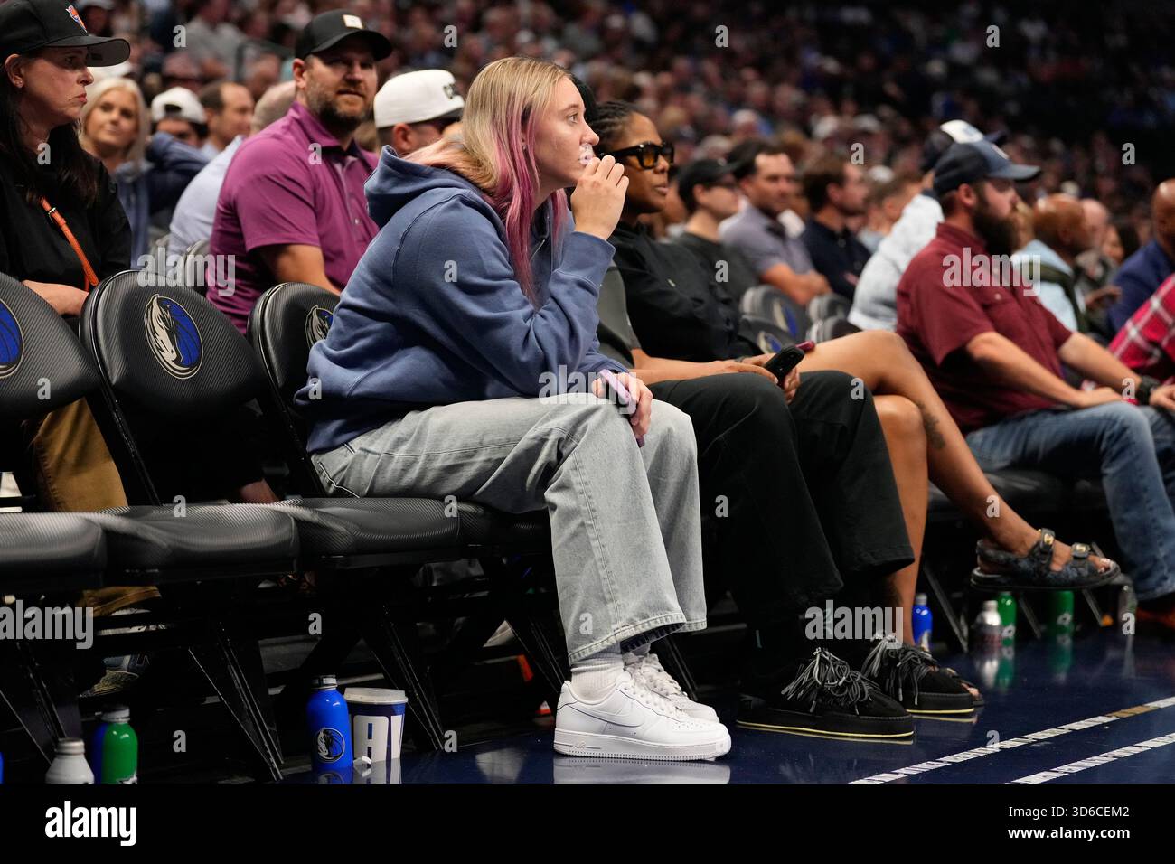 WNBA player Dallas Wings Paige Bueckers, center, sits court side in the ...