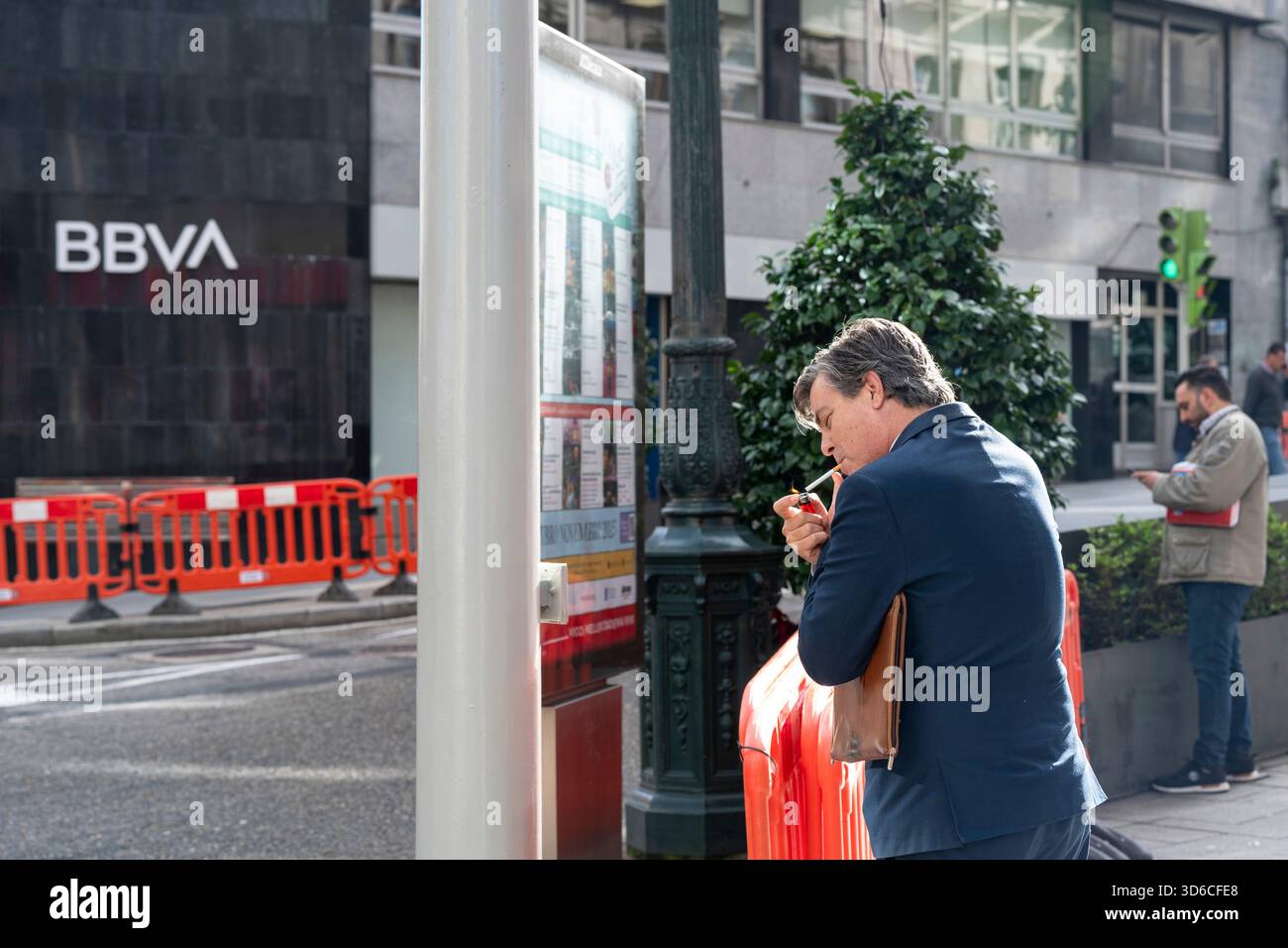 As people walk along the street, the Spanish multinational bank BBVA ...