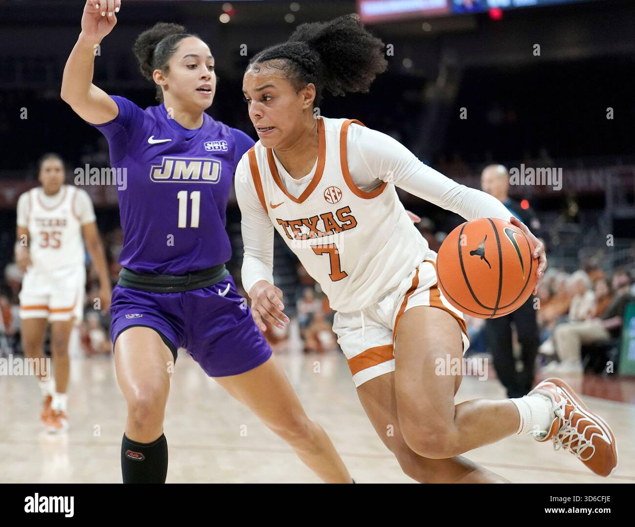 Texas guard Jordan Lee drives to the basket past James Madison guard ...
