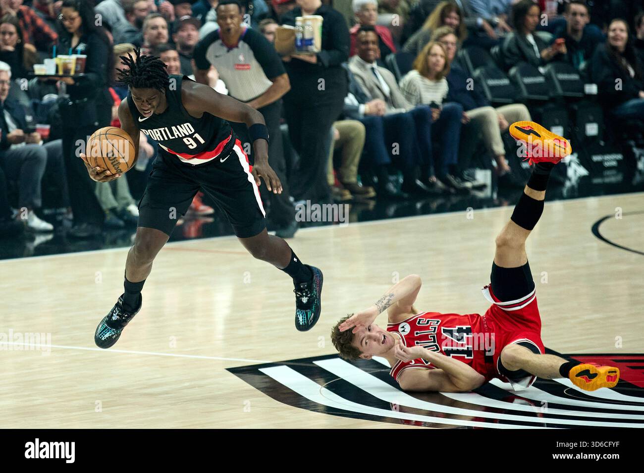 Portland Trail Blazers guard Sidy Cissoko, left, is tripped by Chicago ...