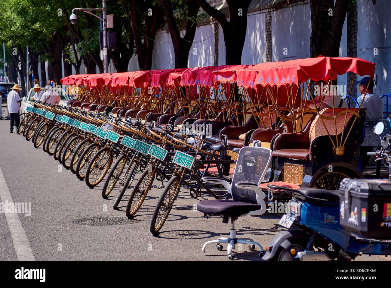 Old rikshaws waiting in a row for clients to cycle through the old ...