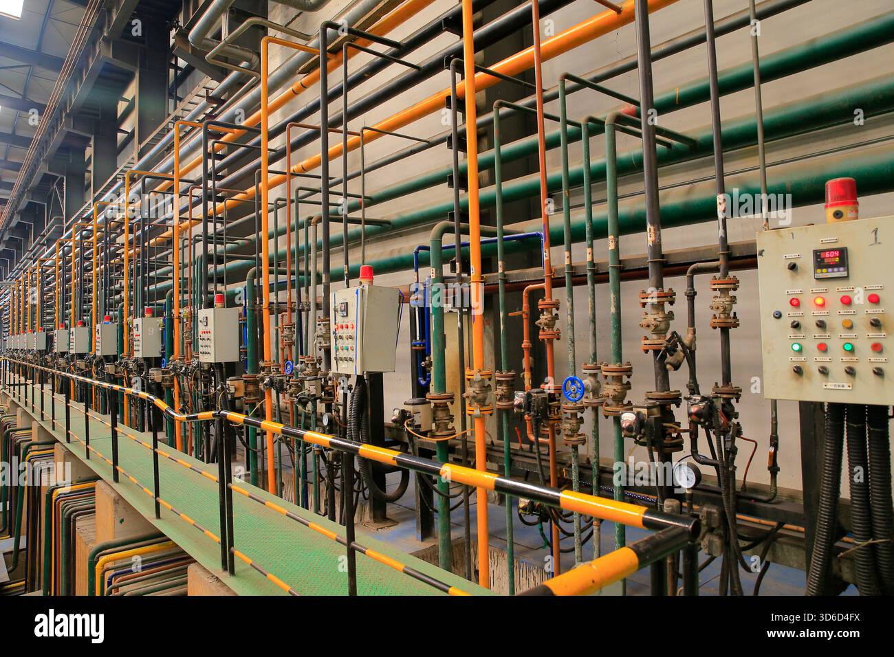 Industrial pipes, control valves and storage tanks in steel mills Stock ...