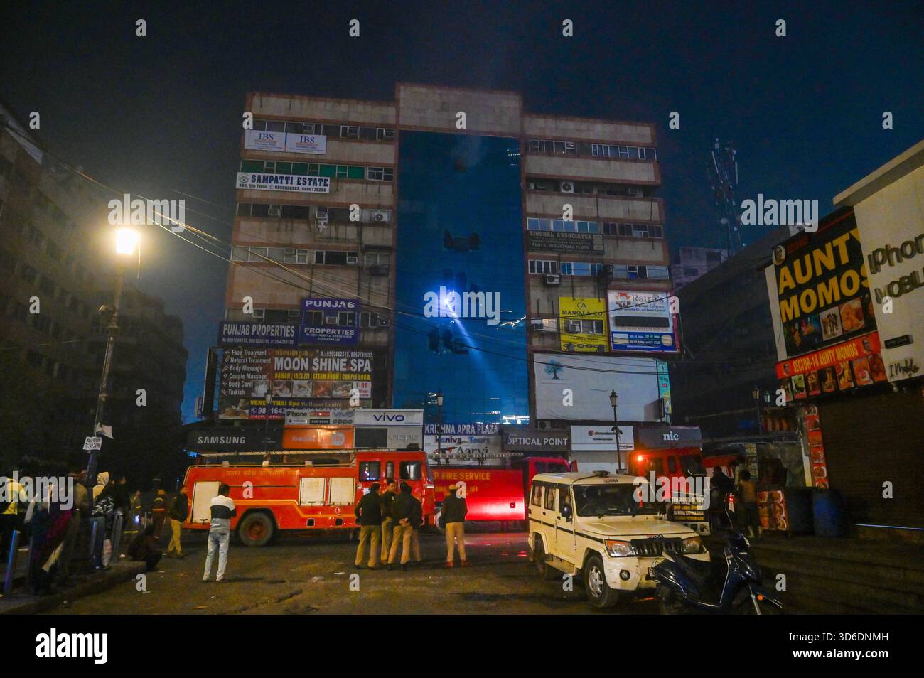 NOIDA, INDIA - NOVEMBER 18: Fire brigade personnel work to extinguish a ...