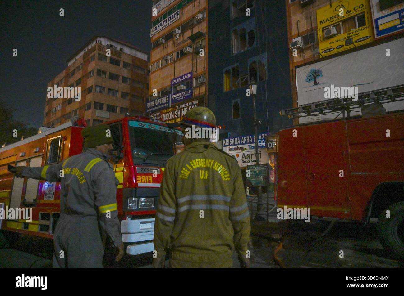 NOIDA, INDIA - NOVEMBER 18: Fire brigade personnel work to extinguish a ...