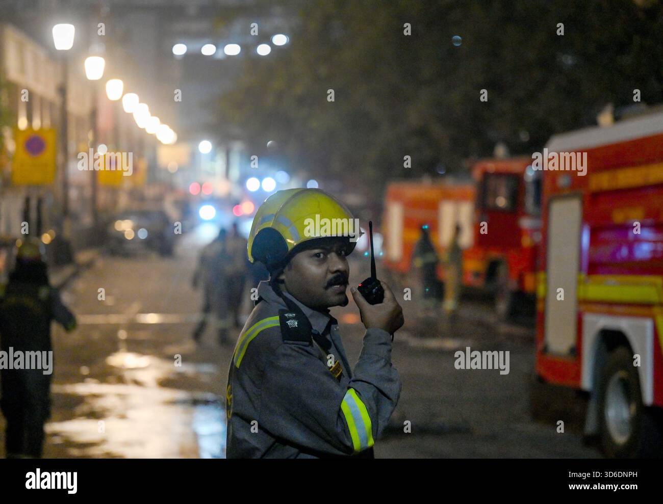 NOIDA, INDIA - NOVEMBER 18: Fire brigade personnel work to extinguish a ...