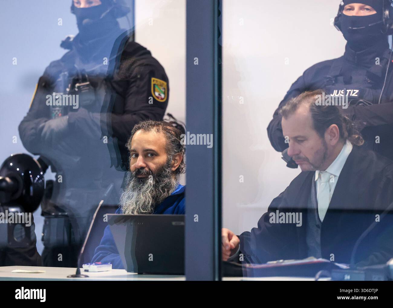 The defendant Taleb al-Abdulmohsen, left, sits next to his defense ...