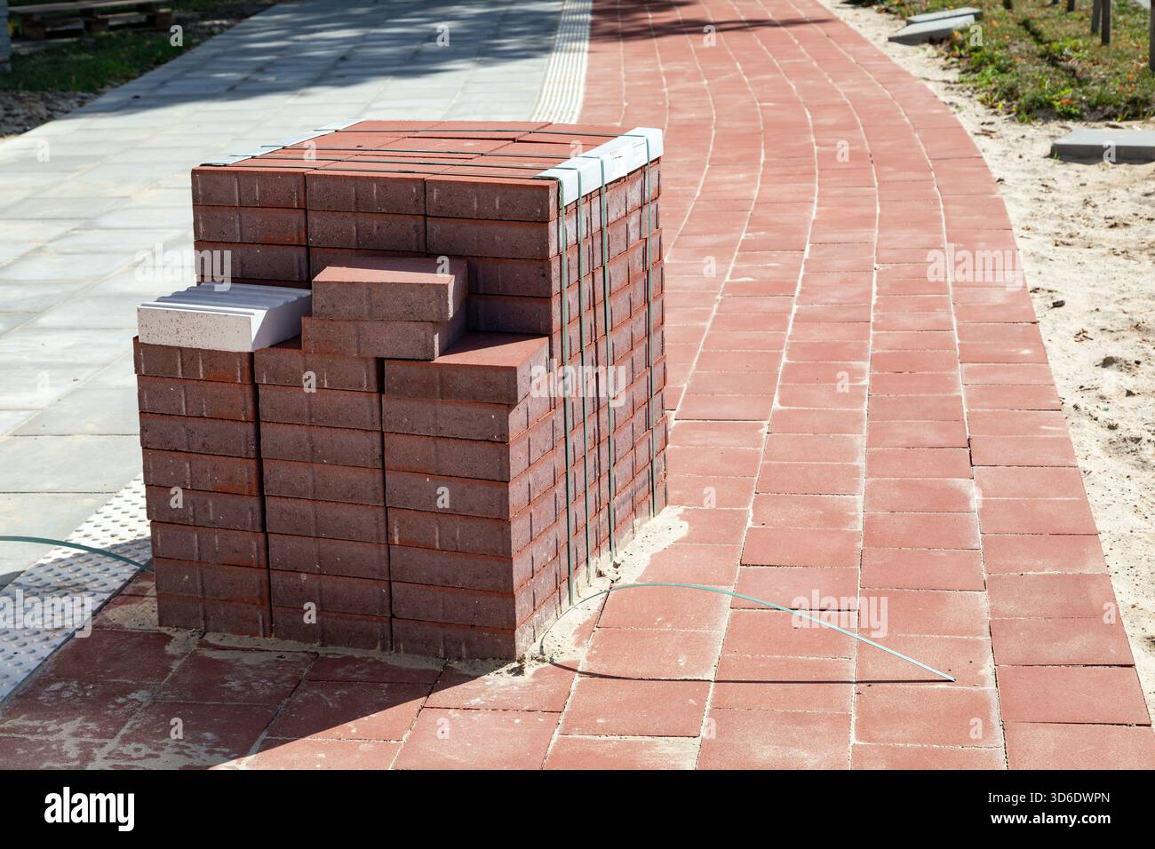 A stack of red concrete blocks stands on a newly built cycle path Stock Photo - Alamy
