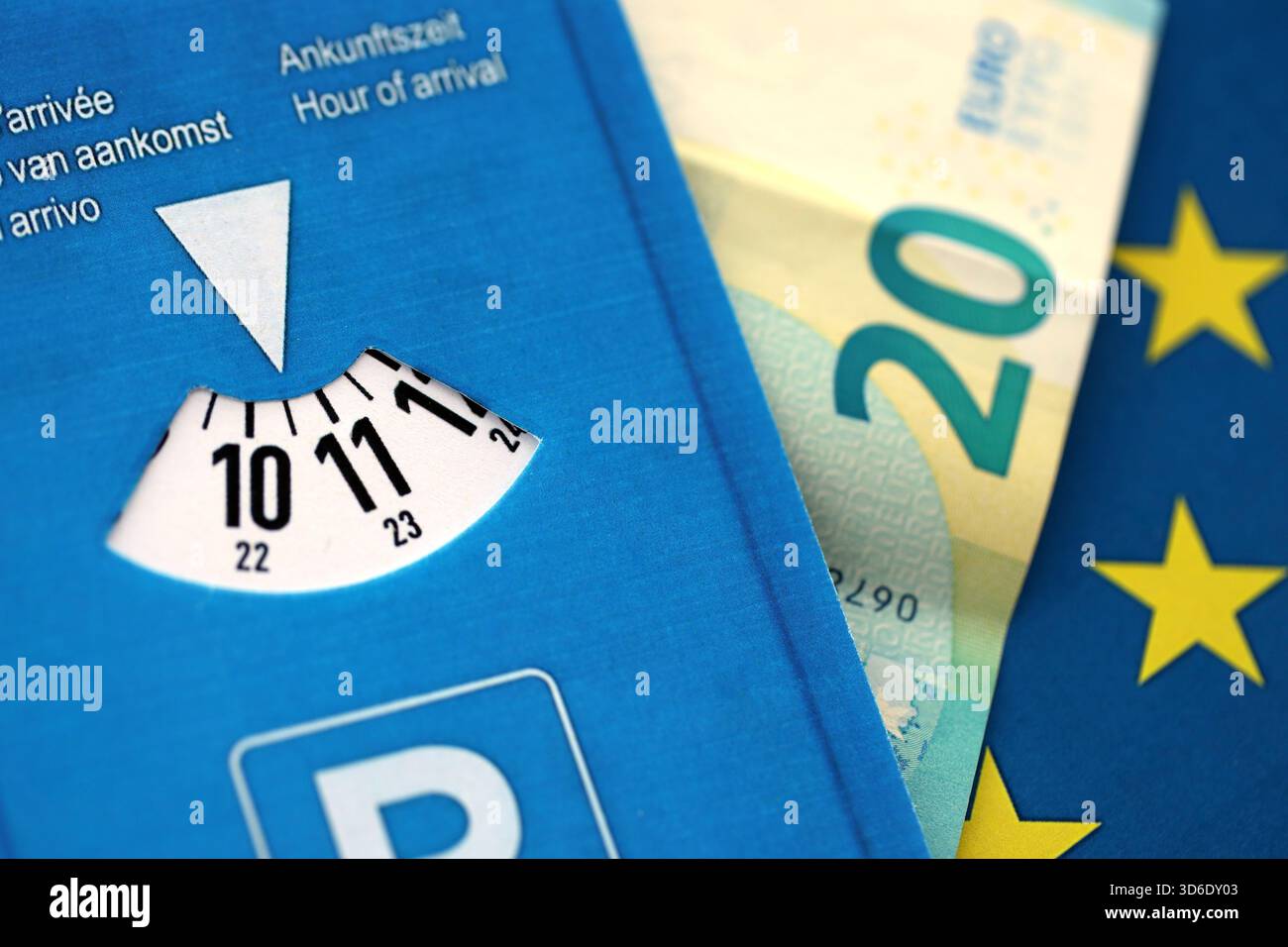 European parking disc with time dial and 20 euro money bill banknote on ...