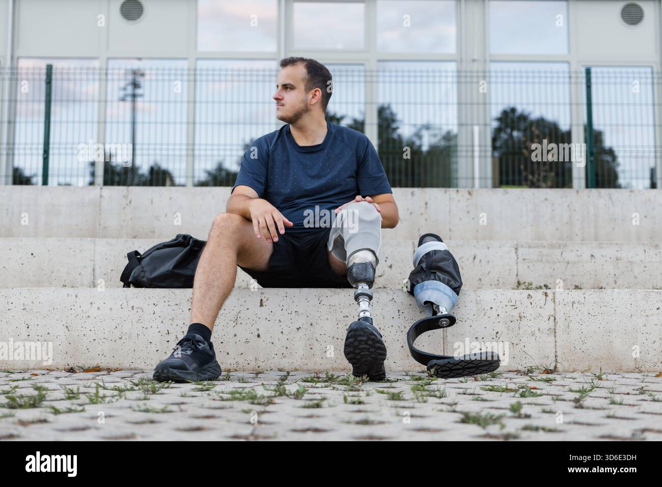 Young amputee with an active lifestyle, putting on his prosthetic leg ...