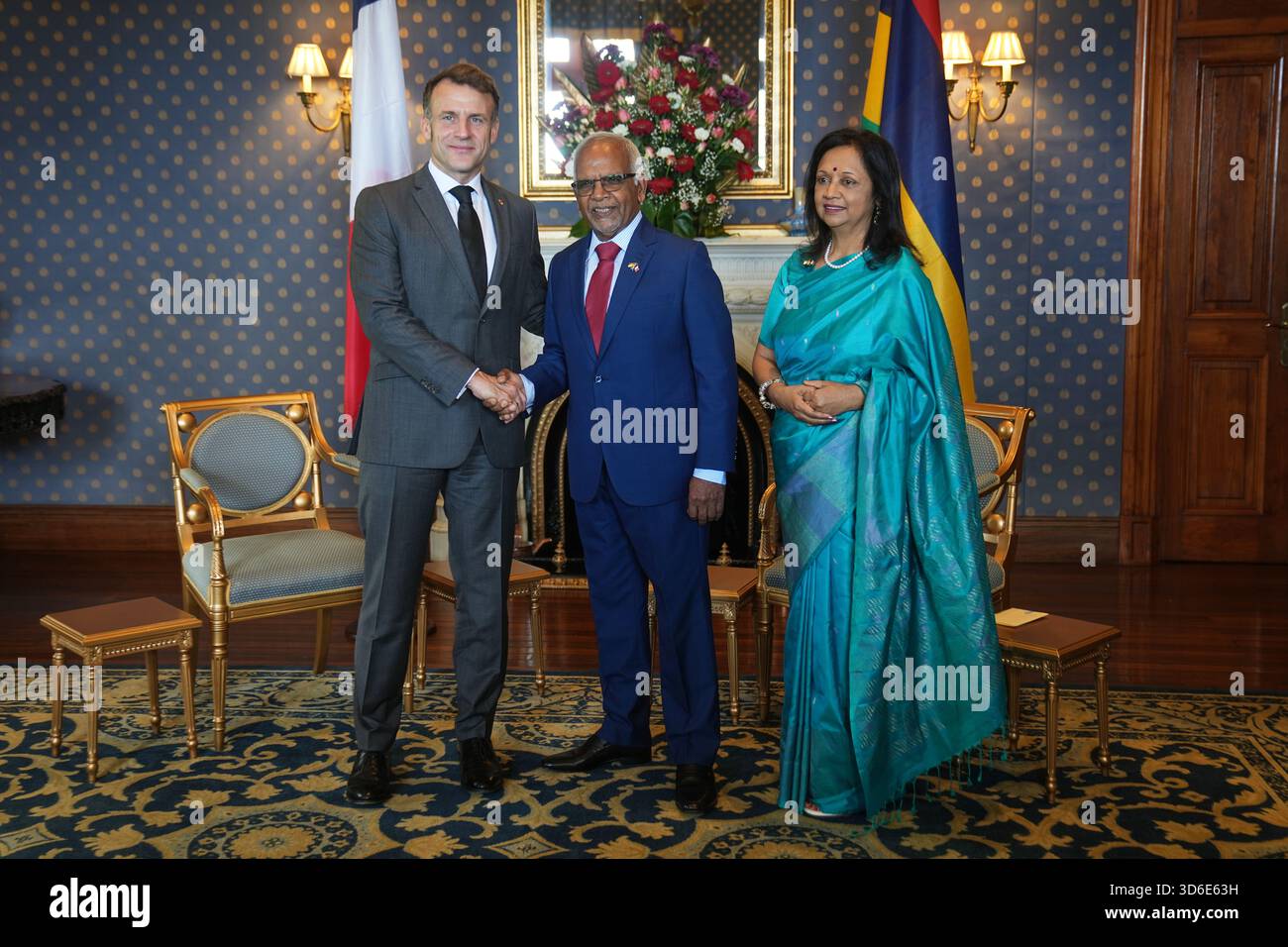 French President Emmanuel Macron, left, shakes hands to Mauritius ...