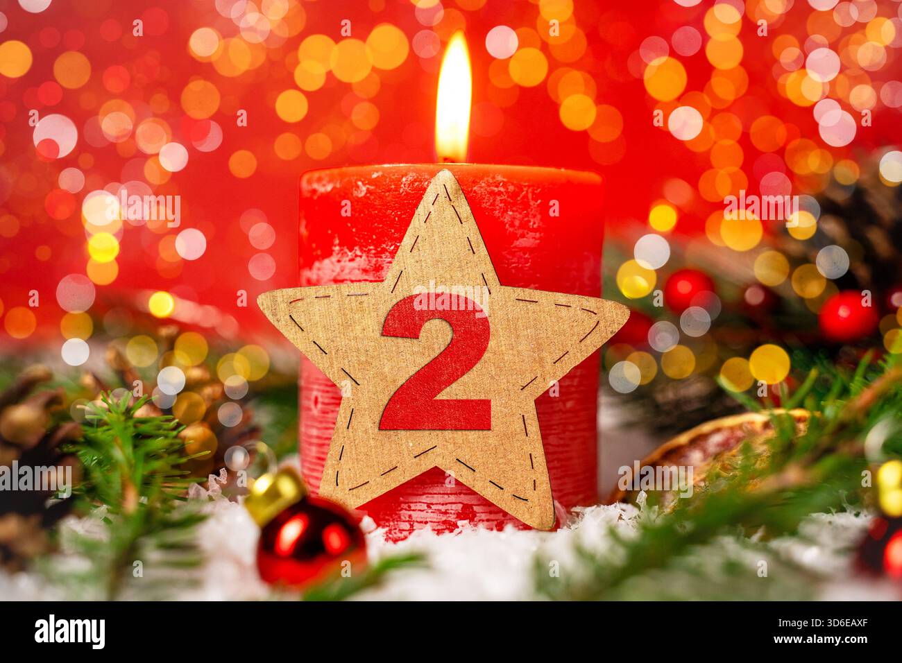Germany - November 19, 2025: Photo montage, Second Advent in warm red tones: A red Advent candle ...