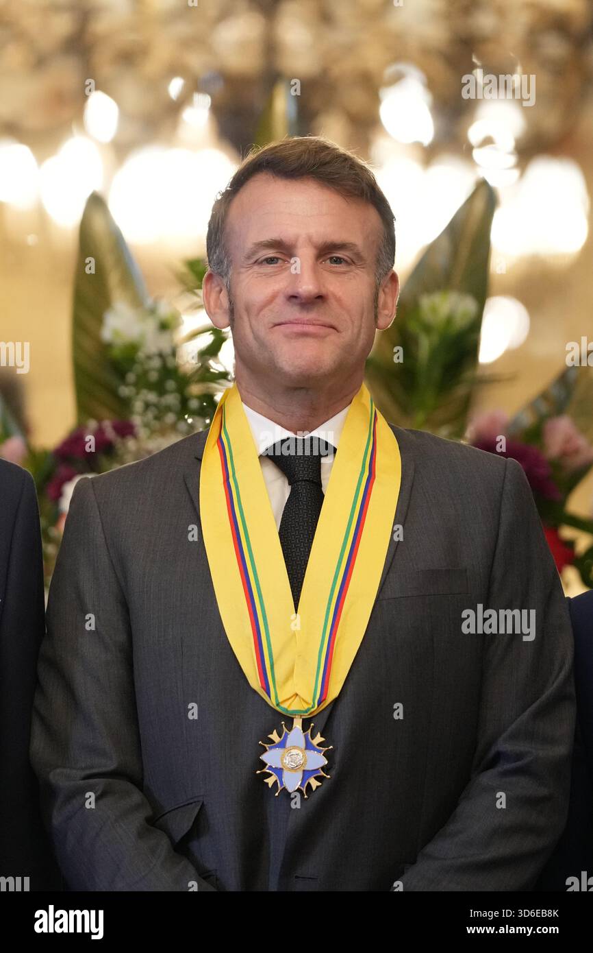 French President Emmanuel Macron poses after being awarded Grand ...