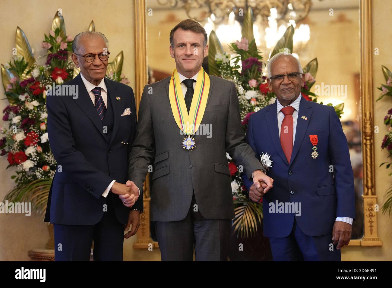 French President Emmanuel Macron, center, poses with Mauritius ...