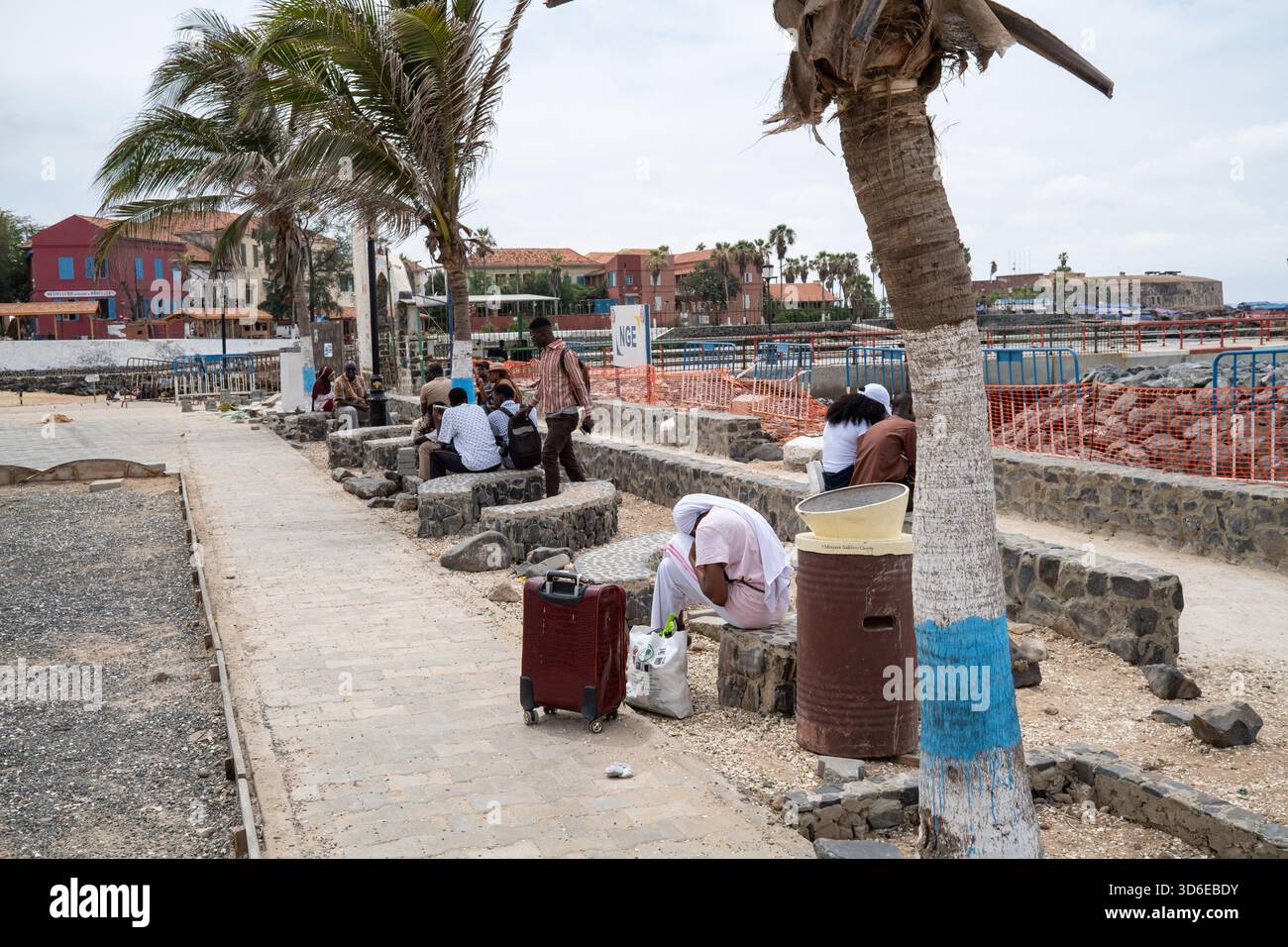 Tourists wait for a shuttle bus on Goree Island in Senegal on 10 July ...