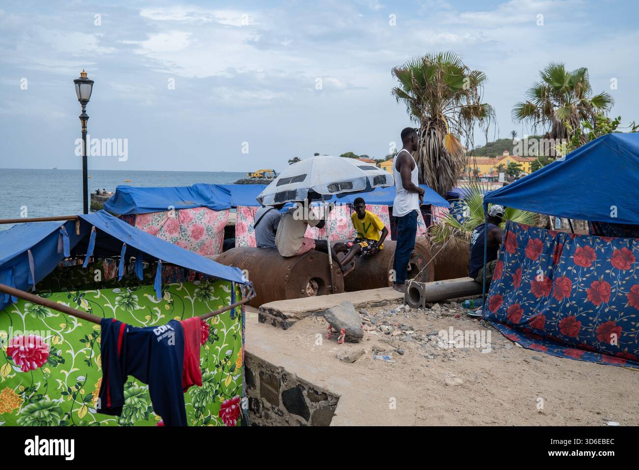 Young people chat under a parasol on Goree Island in Senegal on 10 July ...