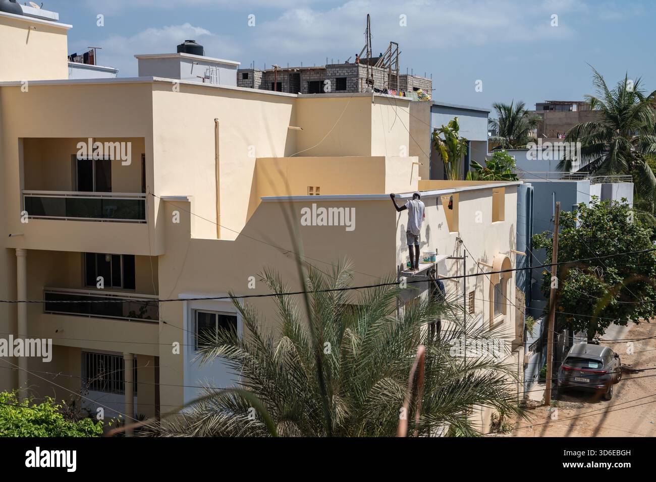 A painter is repainting the facade of a building in the Mamelles ...