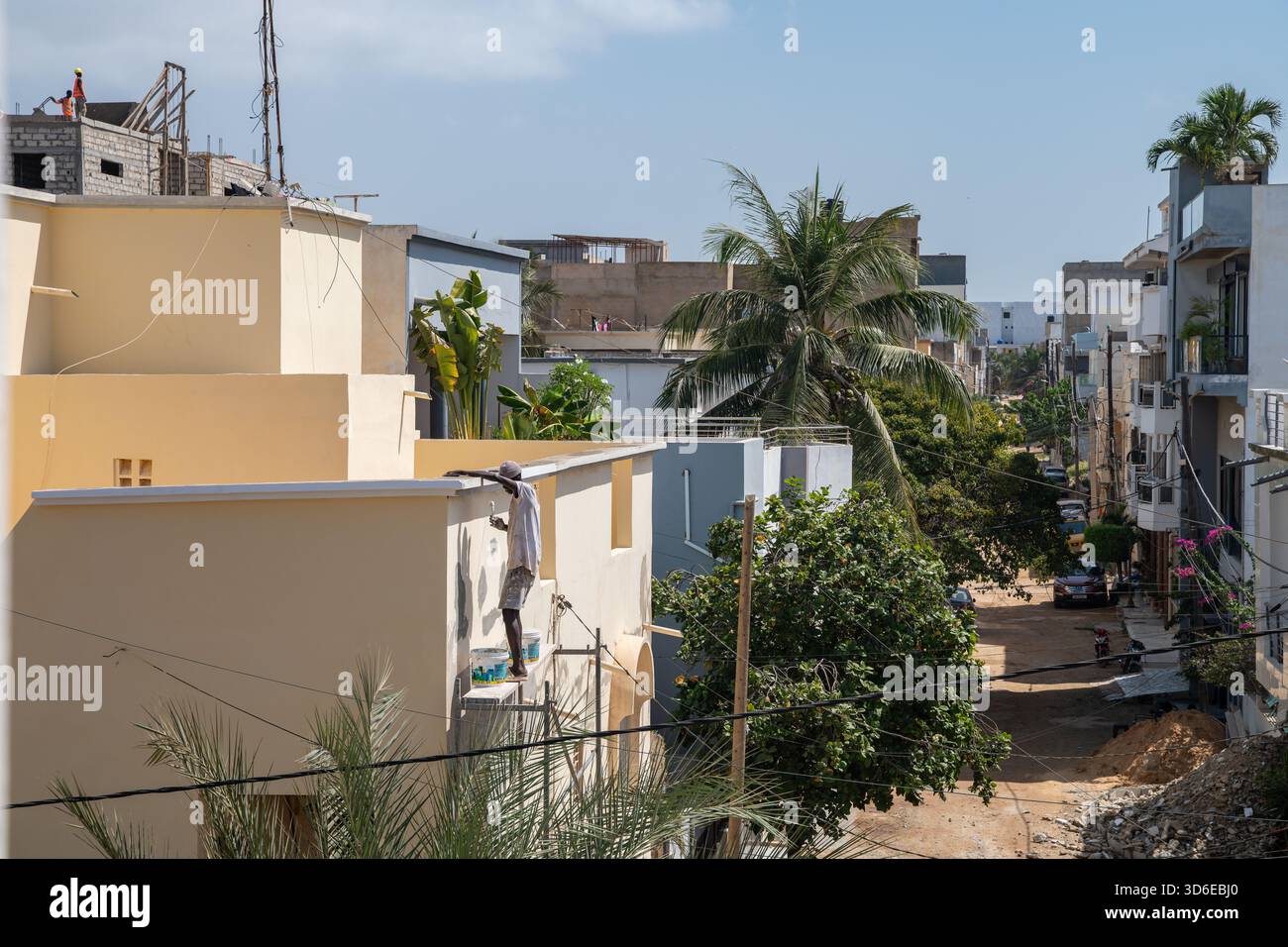 A painter is repainting the facade of a building in the Mamelles ...