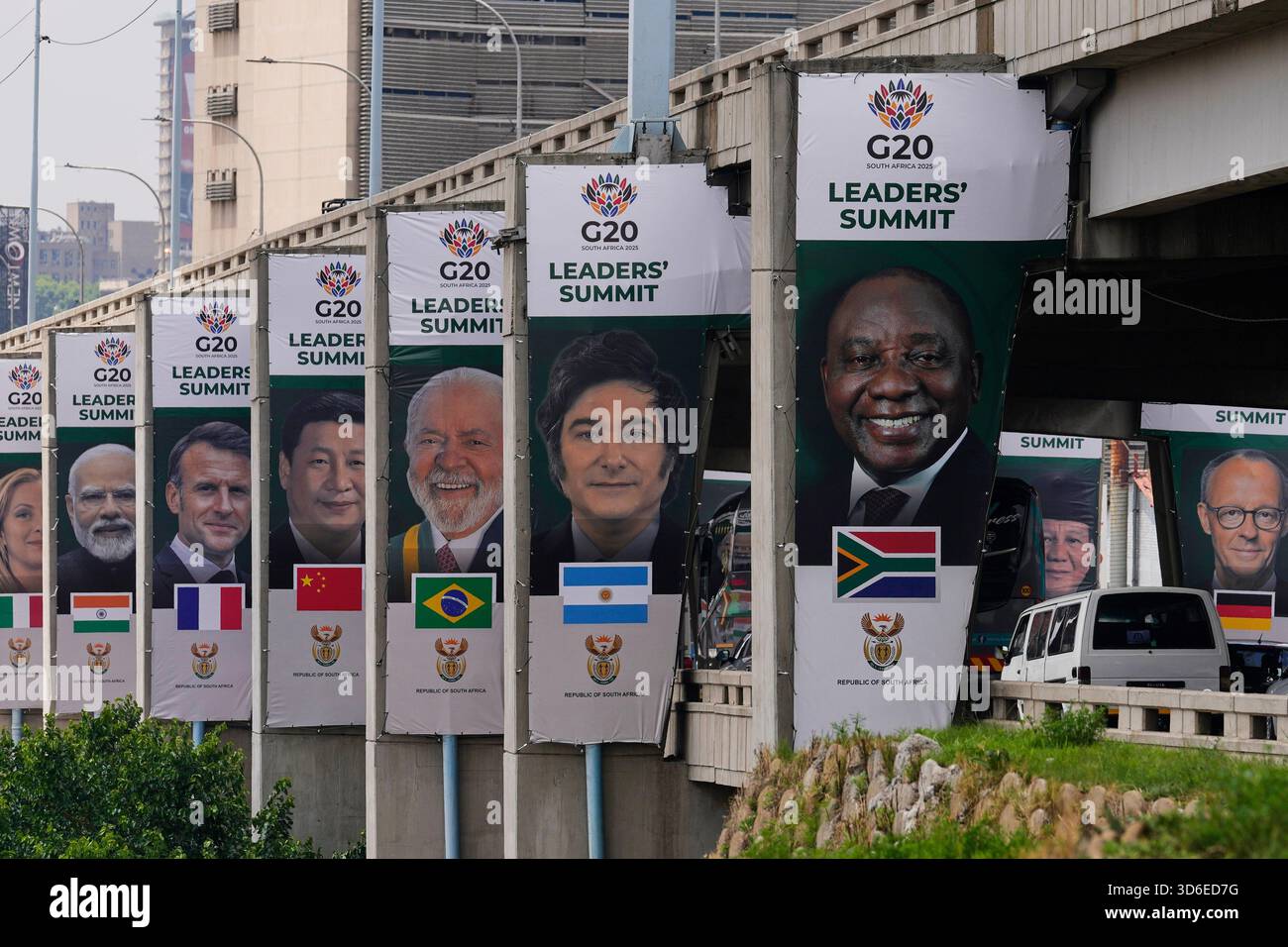 Banners displaying the faces of various G20 leaders are displayed along ...
