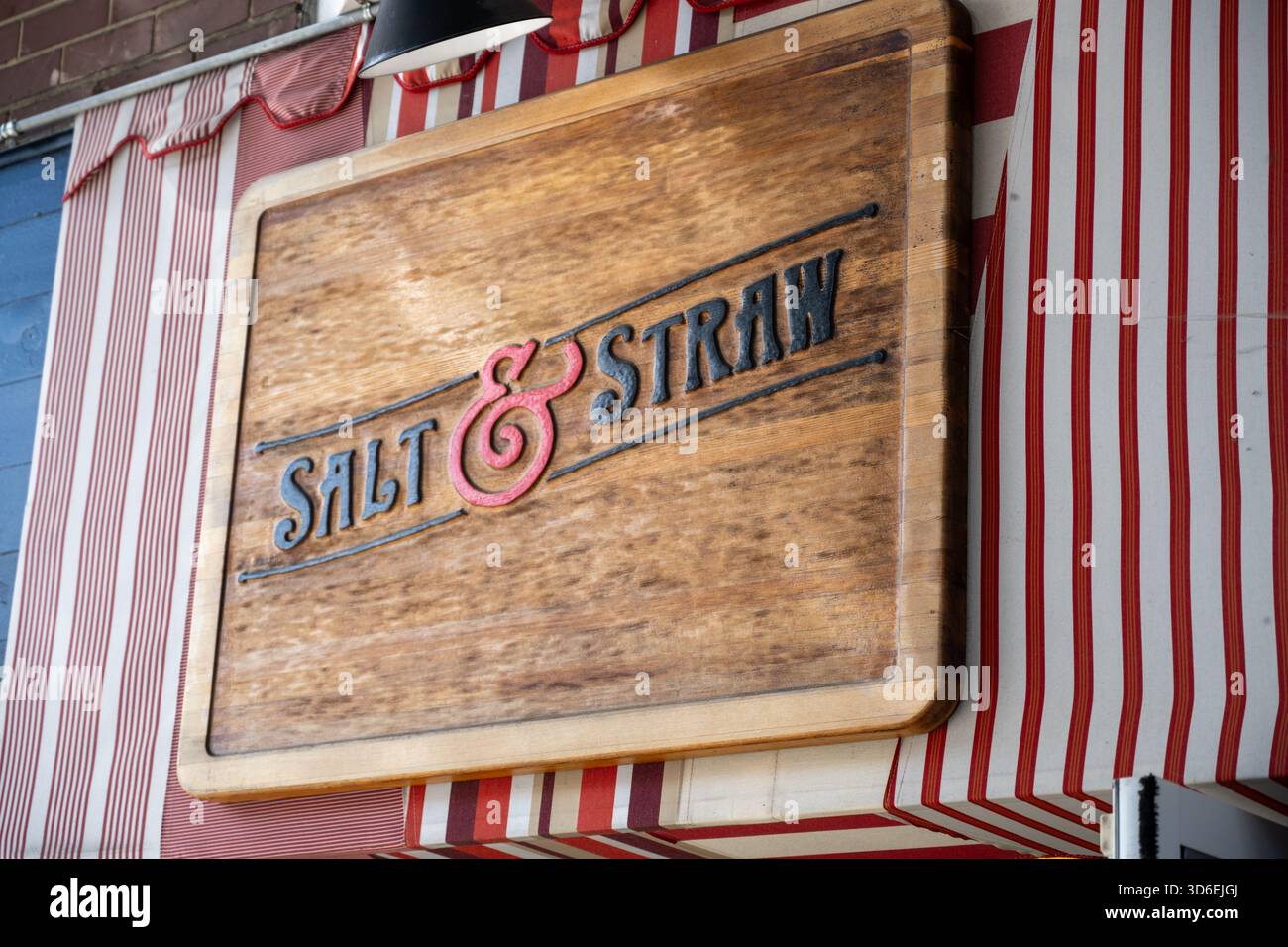 Wooden Salt & Straw storefront sign with red and white striped awning ...