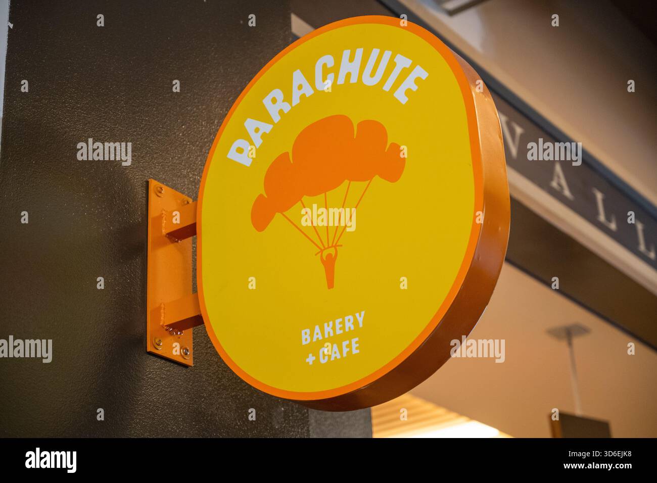 Round Parachute Bakery + Cafe hanging sign with parachute logo in ...